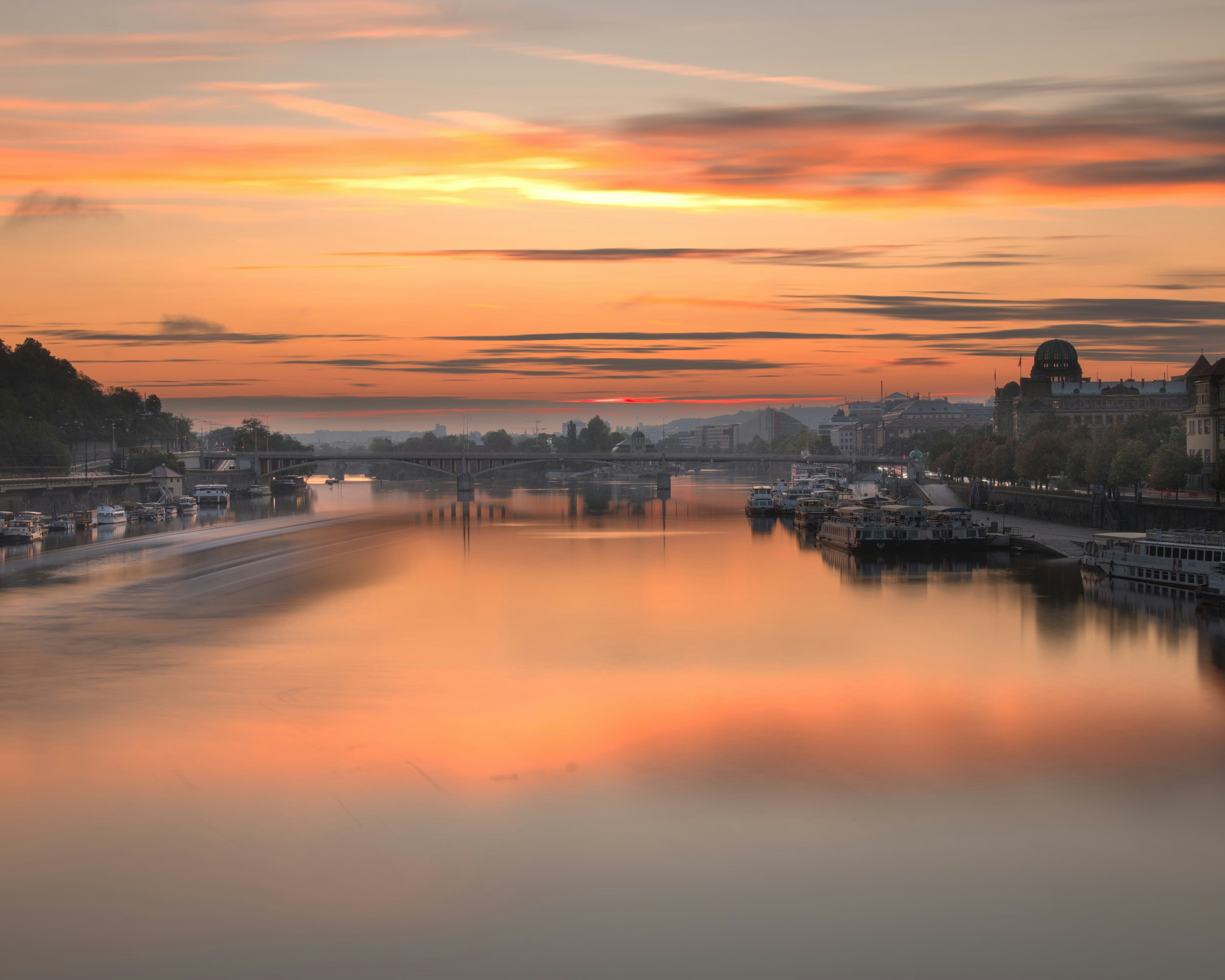 Dusk over the Quiet River: Golden Reflections Along a European Waterfront