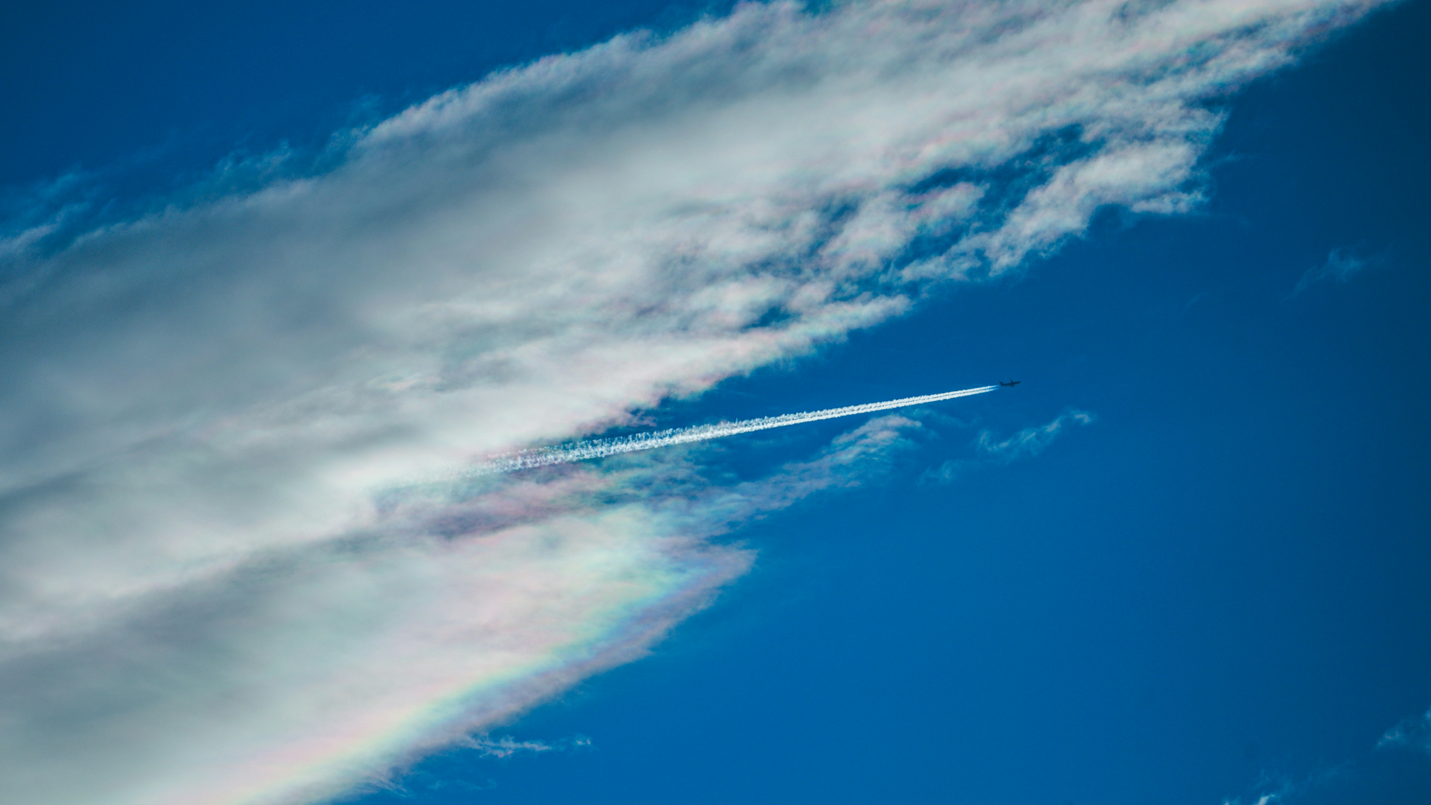 The airplane passing through the colorful clouds