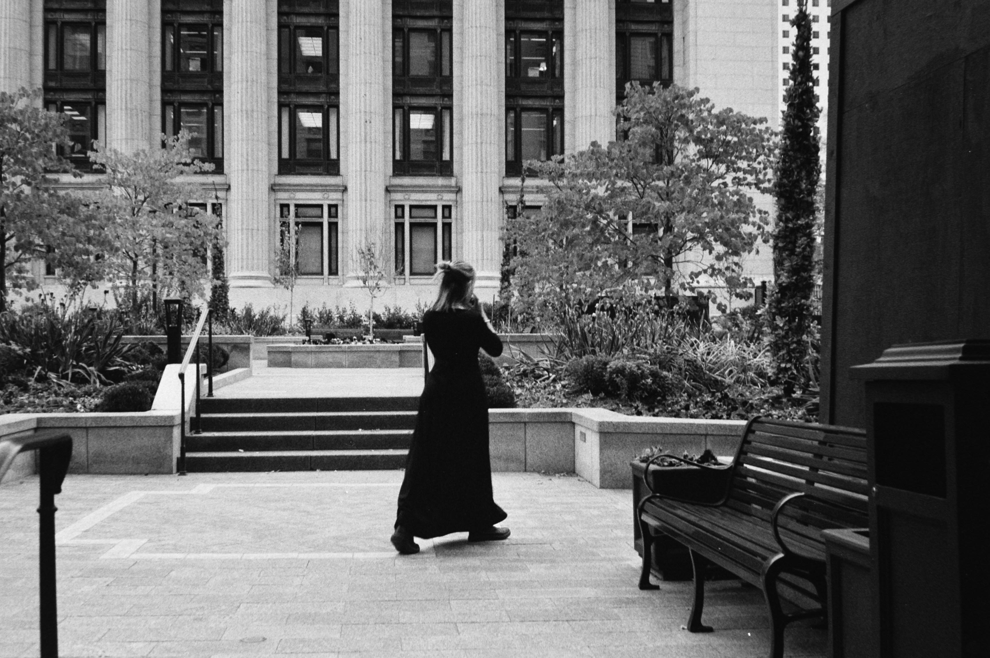 Monochrome Moment: Lone Figure on Neoclassical Steps