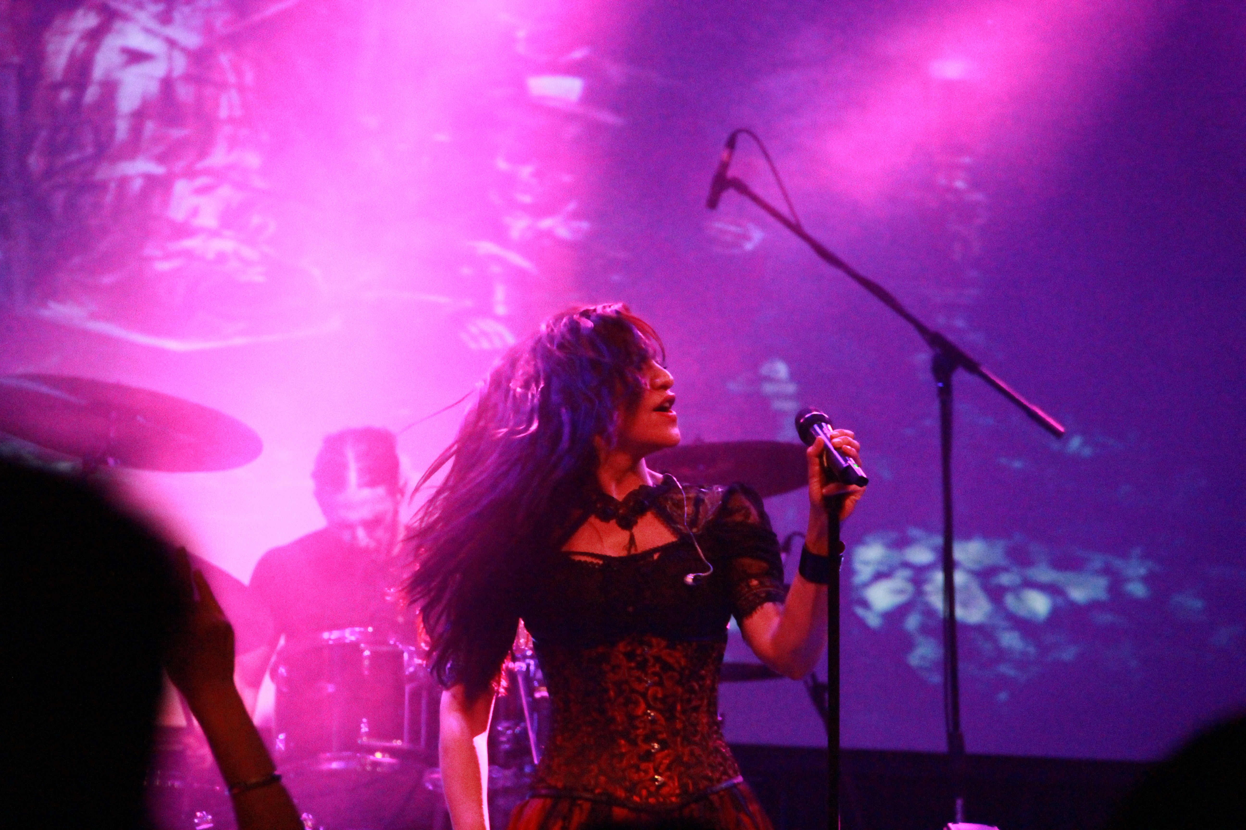 Velvet Corset Under Neon: A Live Stage Portrait