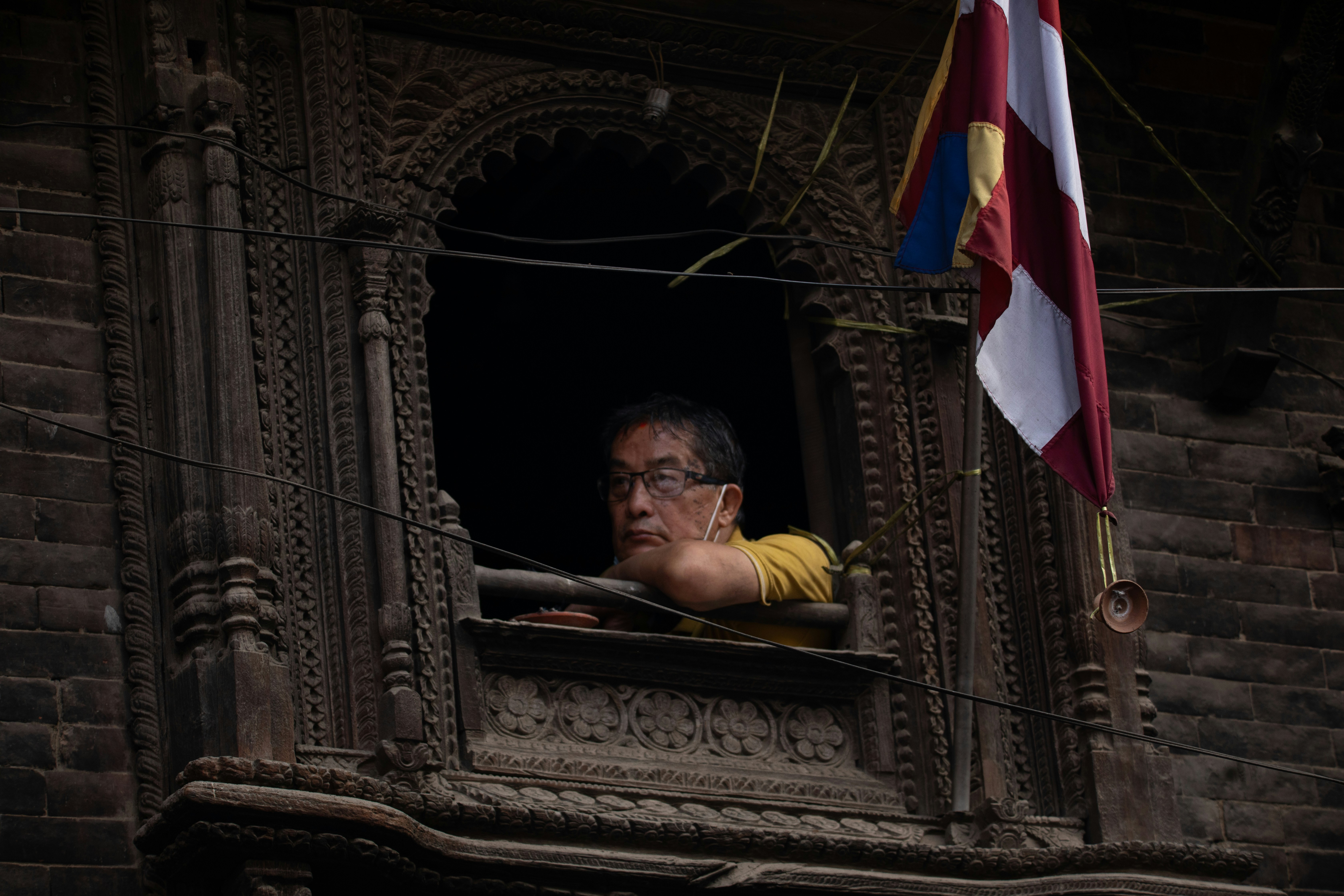 Man looking at Machindranath Jatra Celebration at Patan Durbar Square