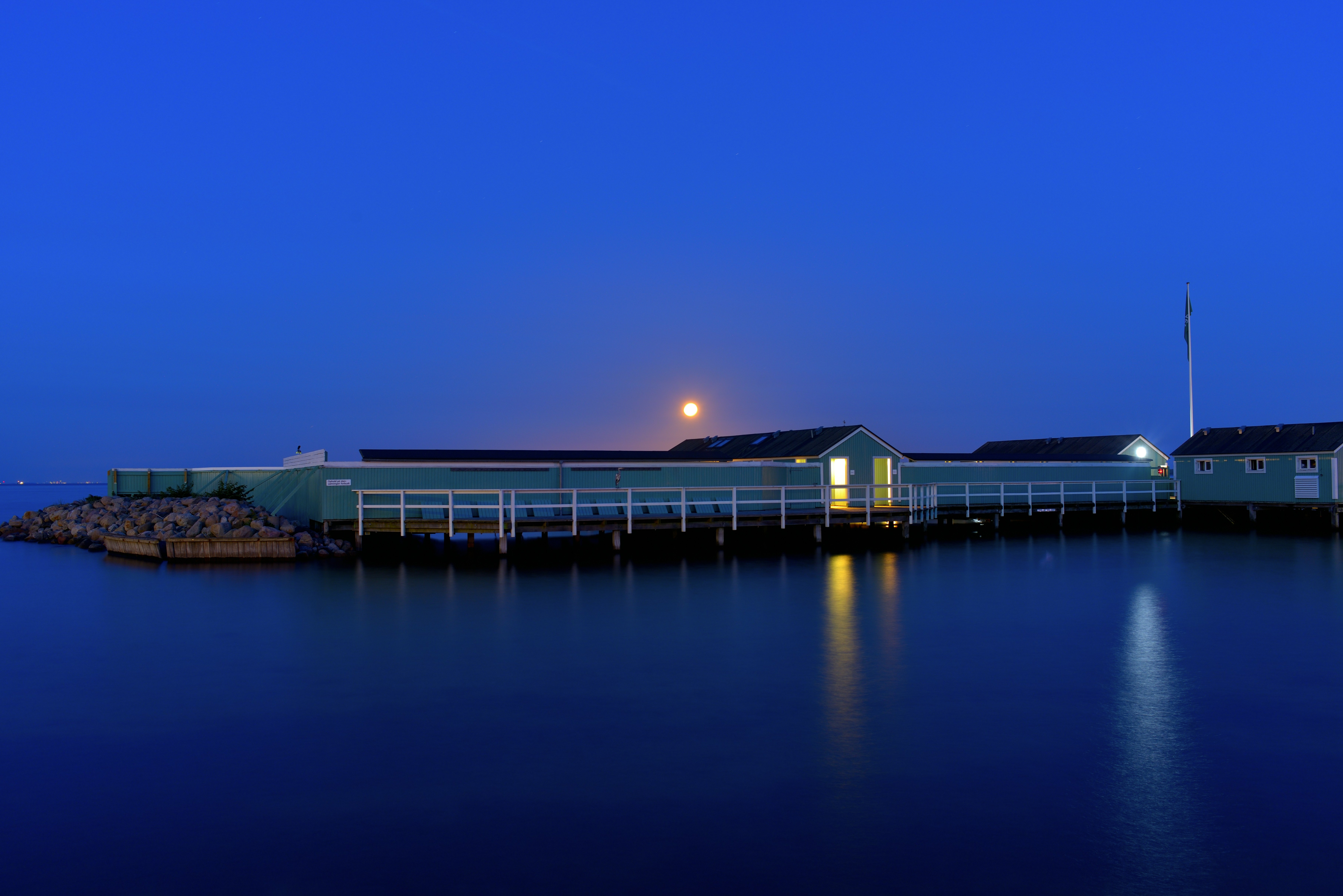 Moonlit Pier: A Quiet Harbor Under Deep Blue Evening