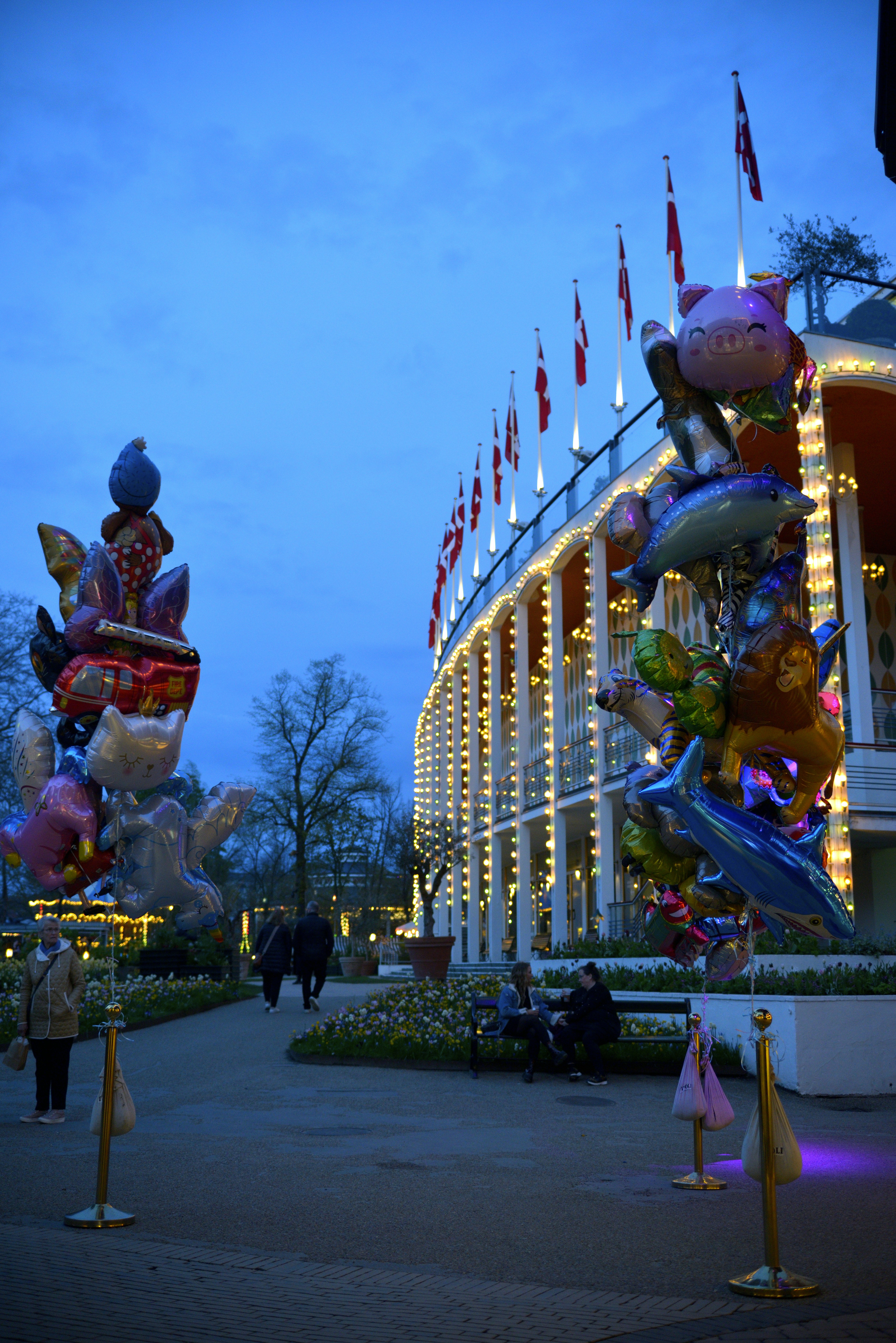 Neon Balloons Frame a Twilight Carnival Terrace