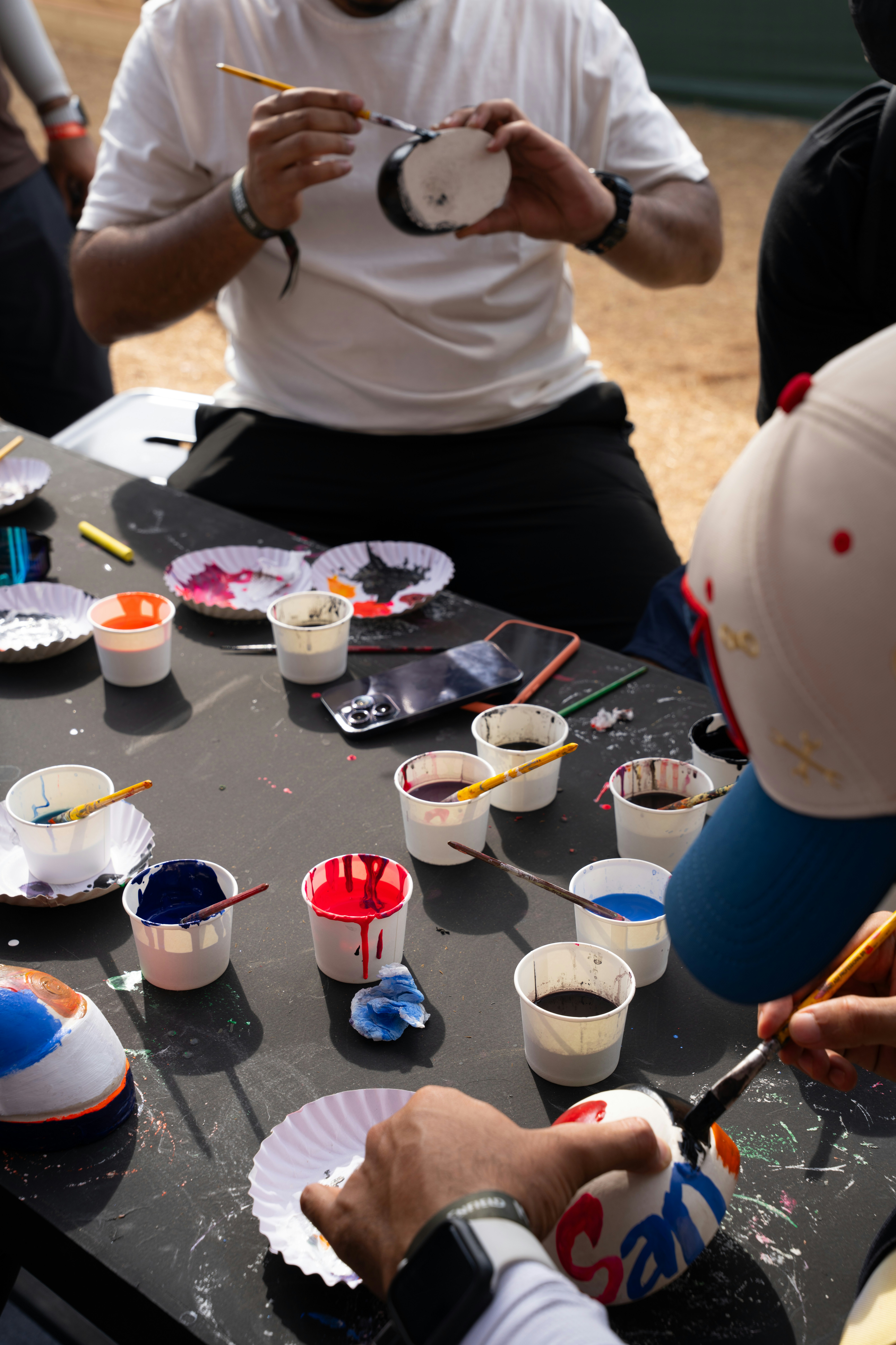 Hands at Work: Crafting Color on a Painted Plate