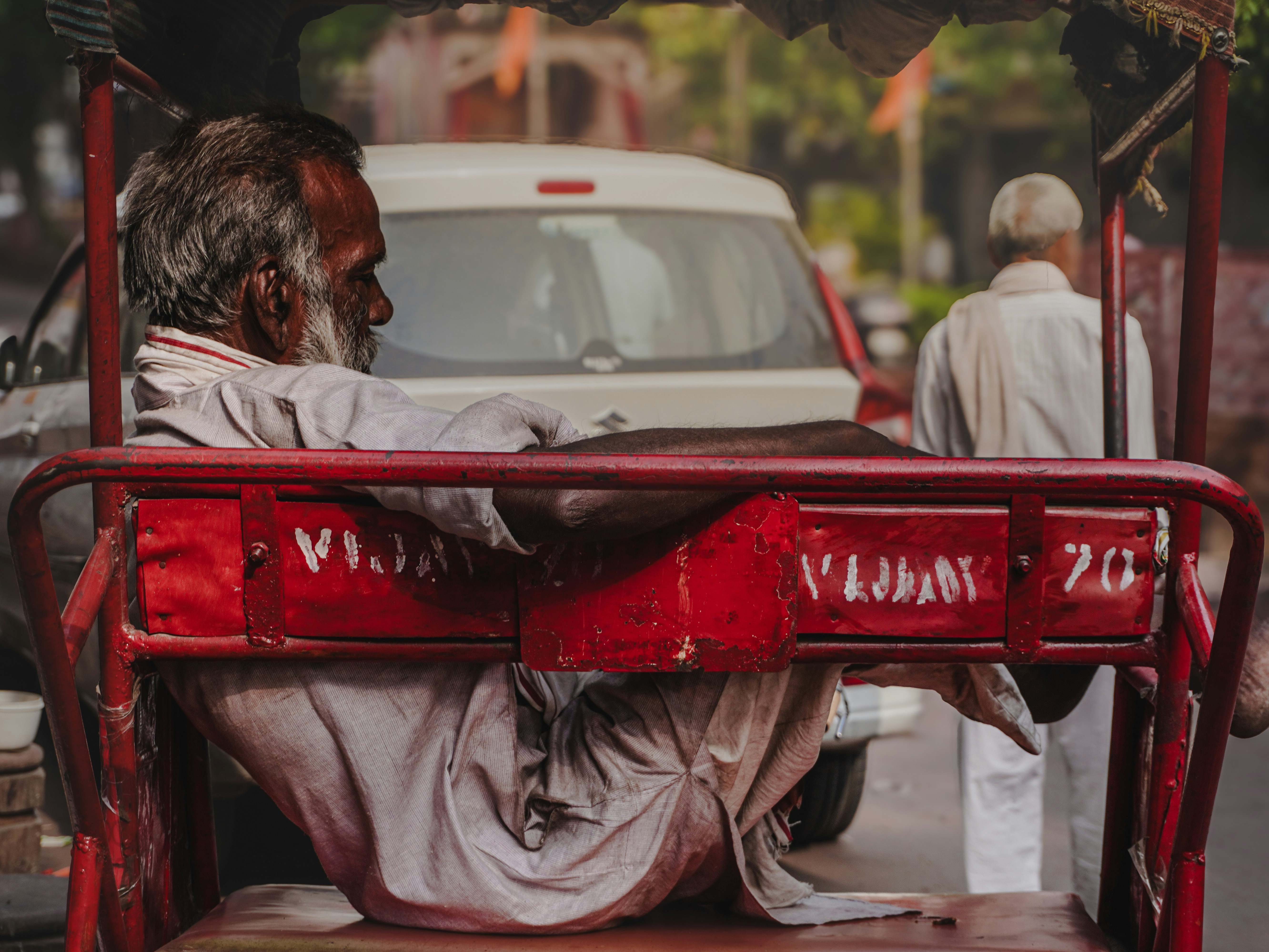 Red Rickshaw Reverie: A Quiet Pause on a Busy Street