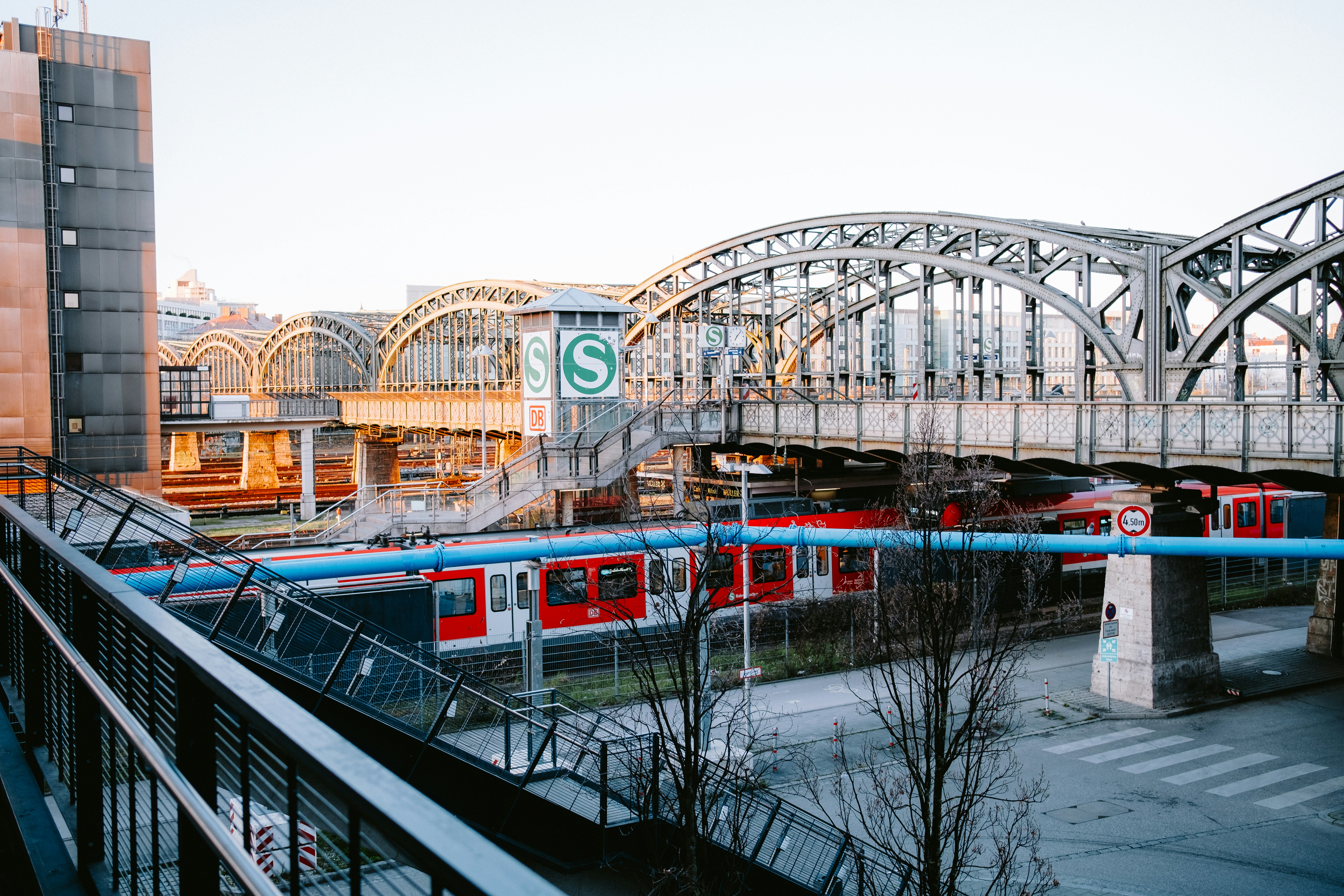 Under Arches and Rails: A Red S-Bahn Crossing the Frame