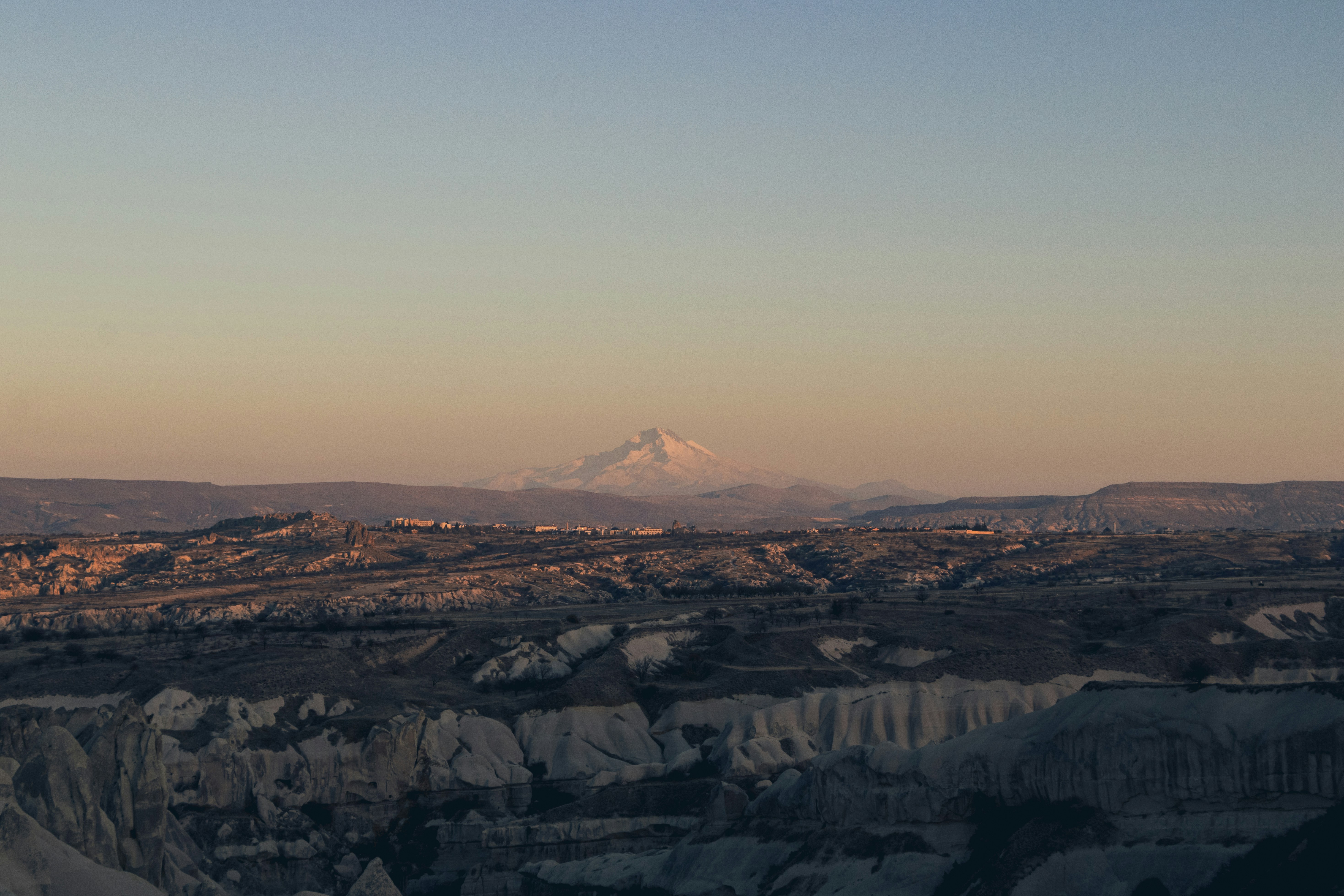 Distant Peak at Dusk Over Layered Valleys