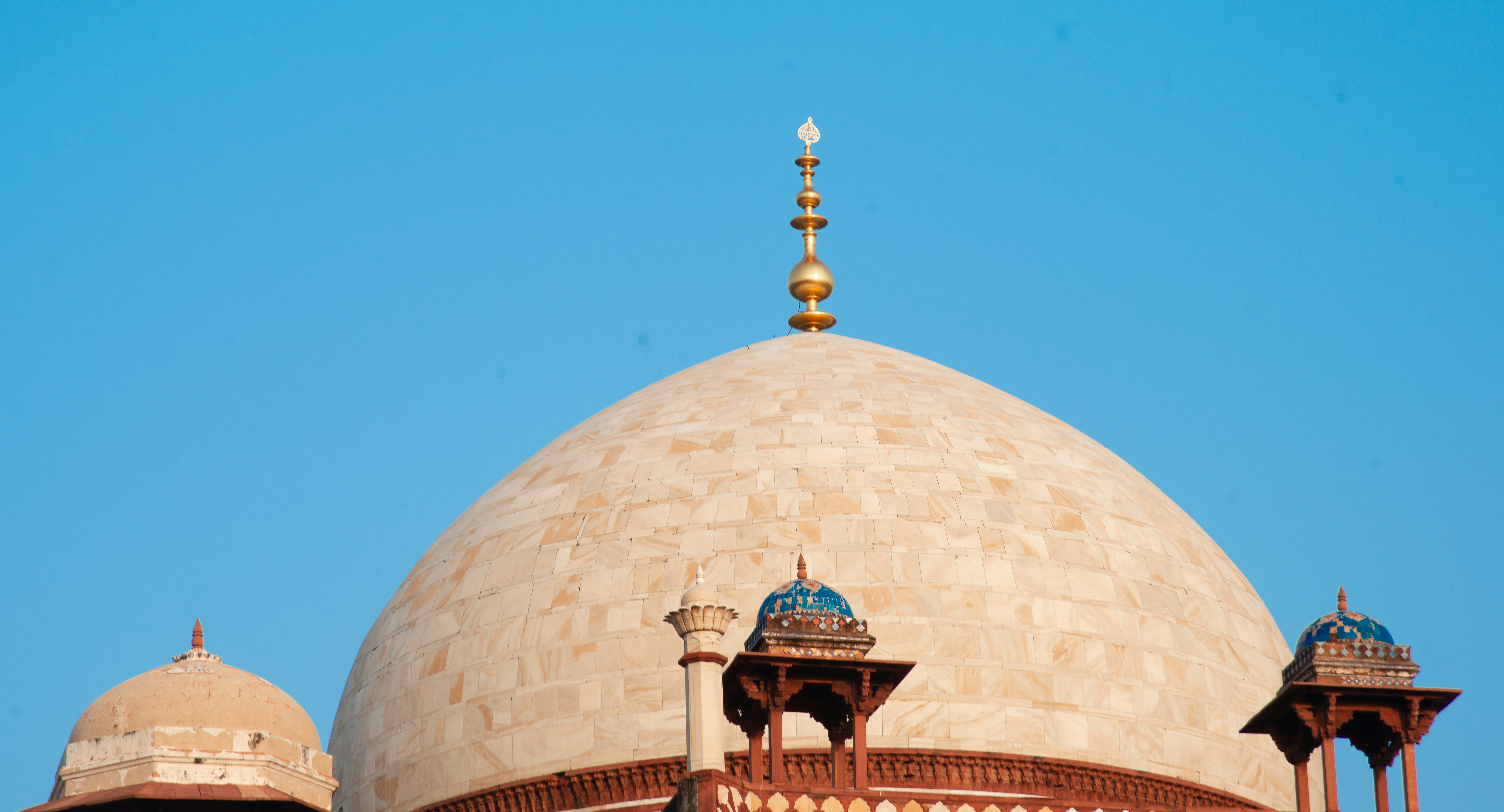 Humayun Tomb's massive, bulbous white marble dome crowned with a golden finial.
