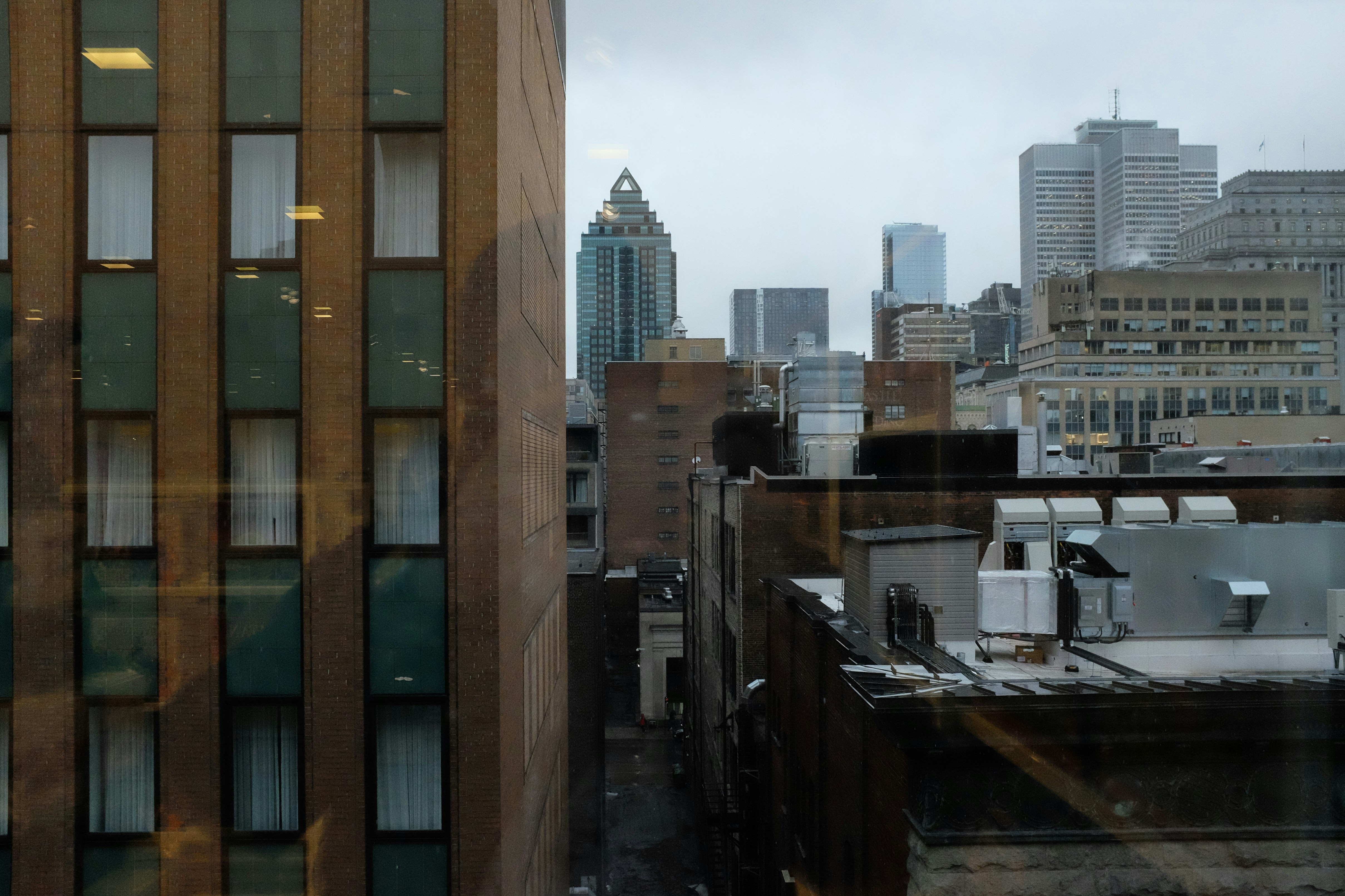 Brick and Glass at the City Edge: A Window-Frame Skyline