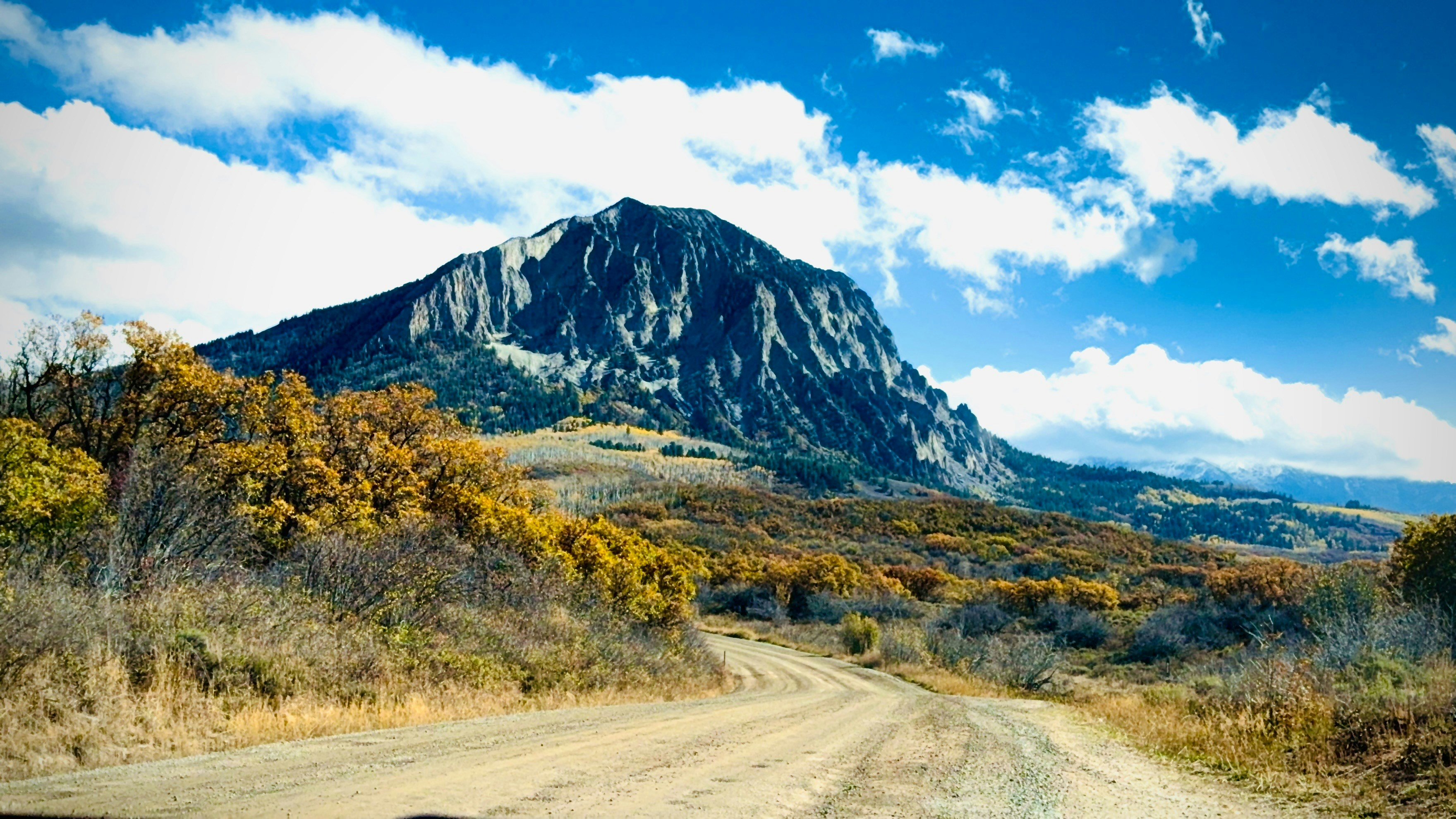 Rugged Peak Over a Winding Desert Road