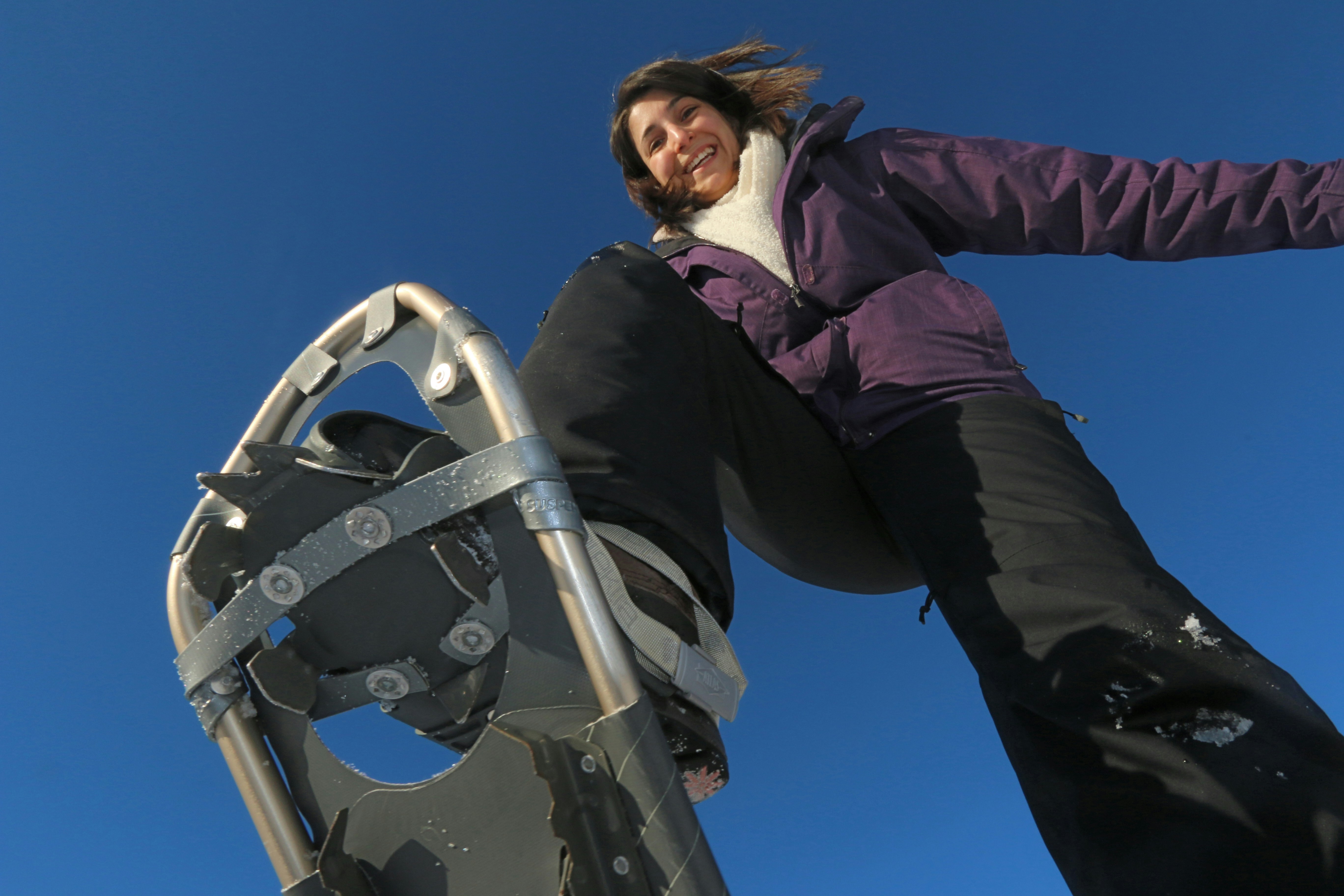 Blue Sky Ascent: A Low-Angle Portrait of a Snow-Adventure Enthusiast