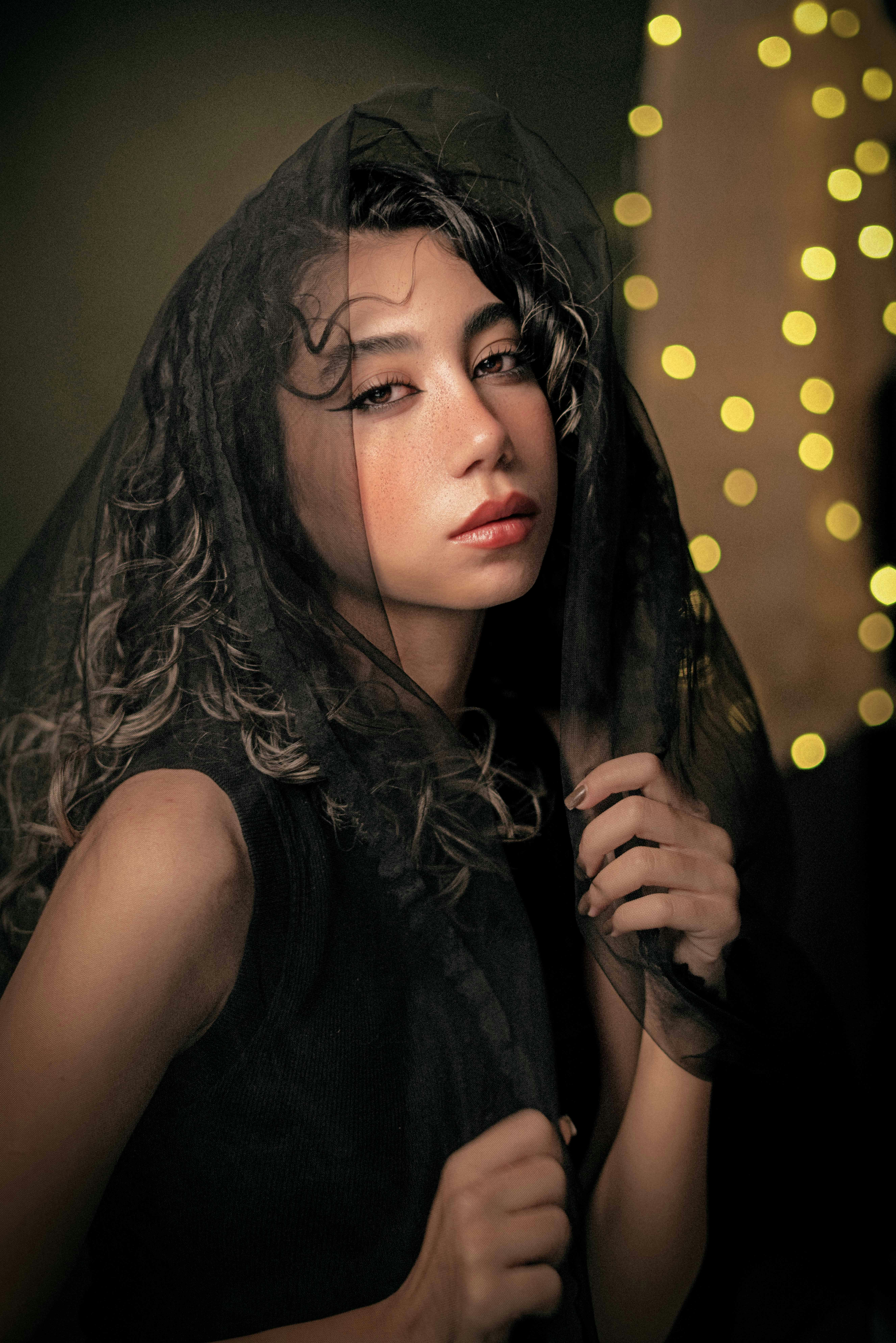 Veiled Glow: A Quiet Gaze Under Golden Orbs