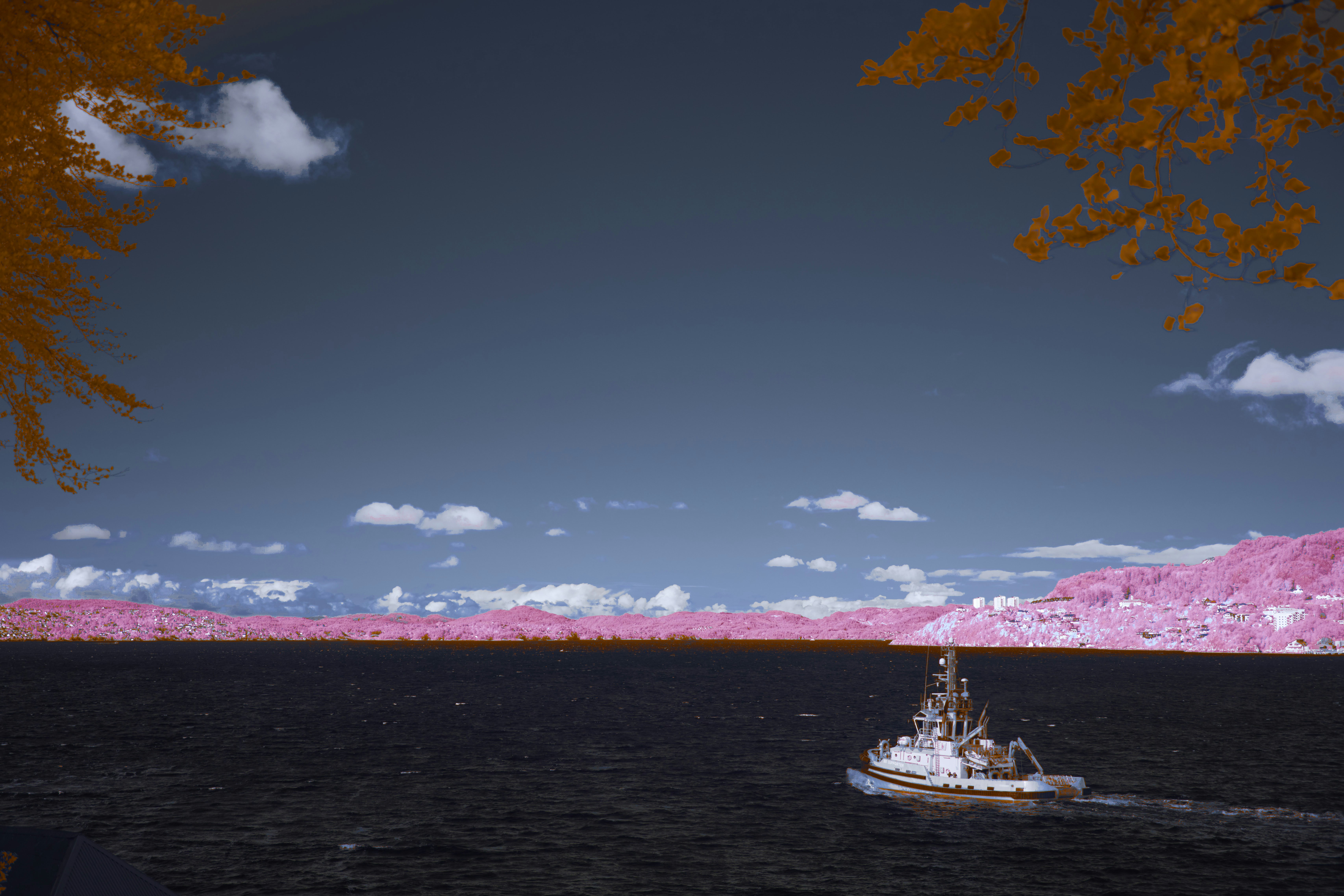 Infrared Seascape: A Tiny Tug on a Neon Pink Horizon