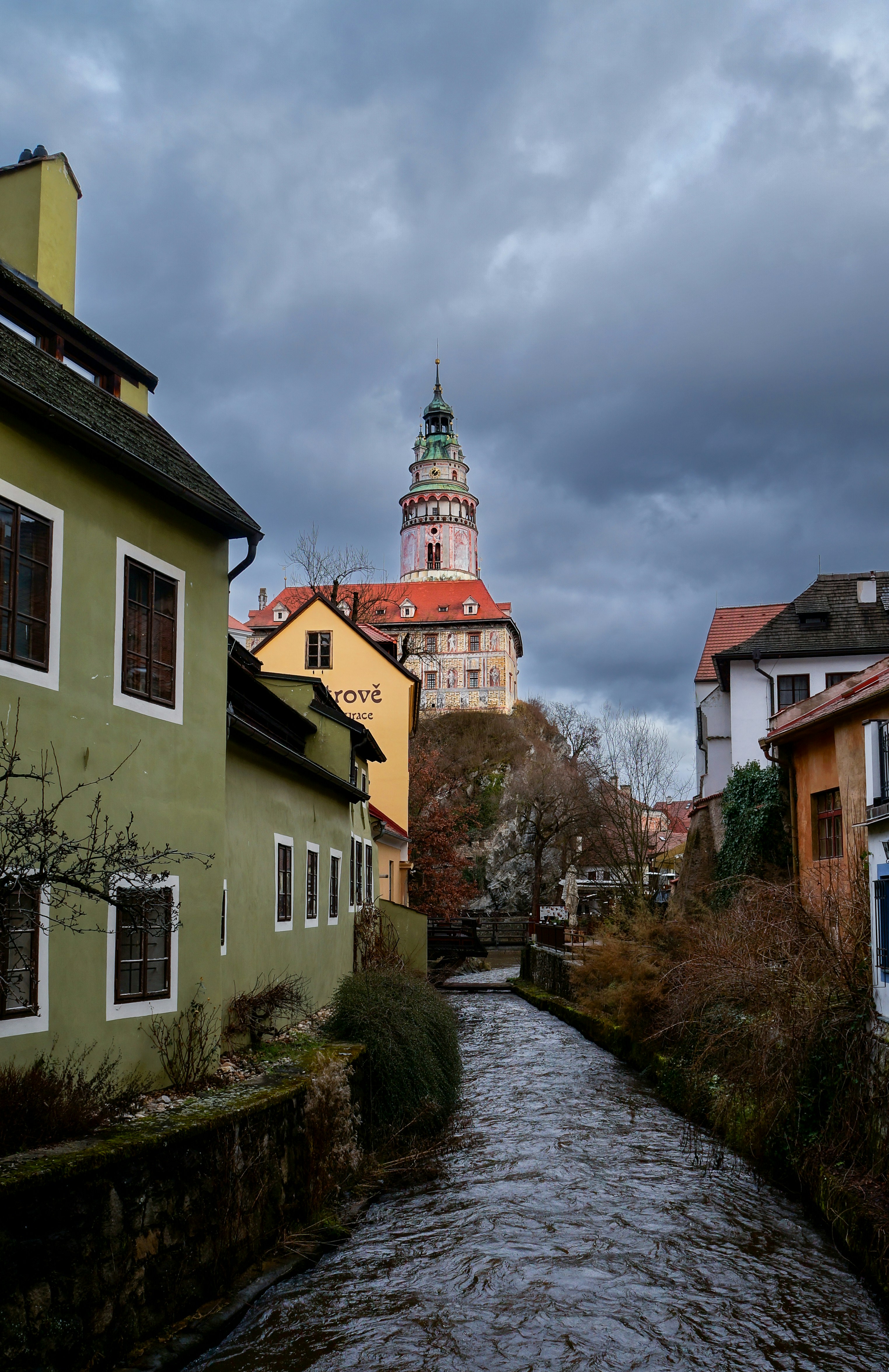 Clock Tower at the End of a Cobblestone Canal