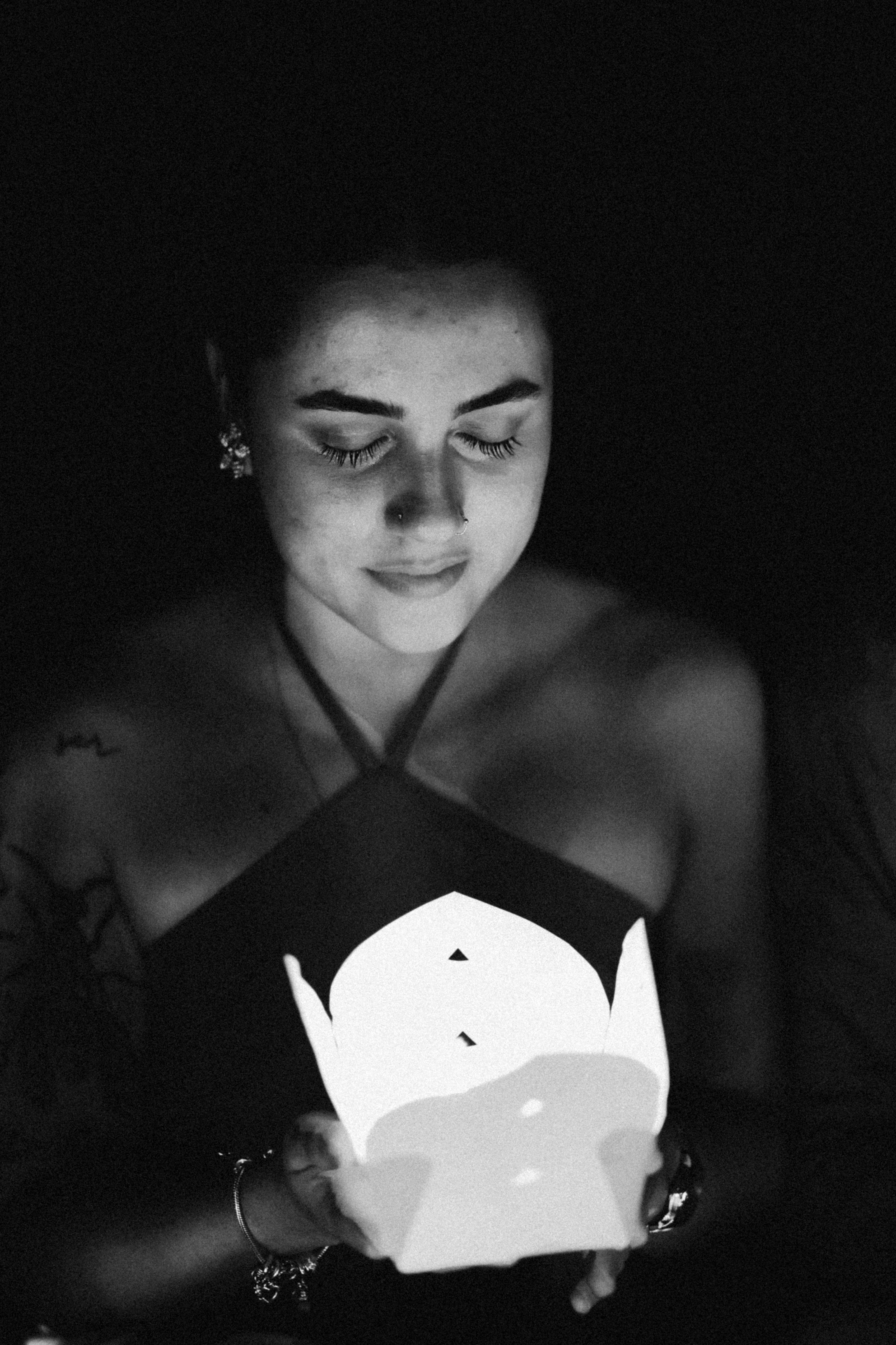 Soft Glow in the Dark: A Woman Illuminates a Cardboard Lantern