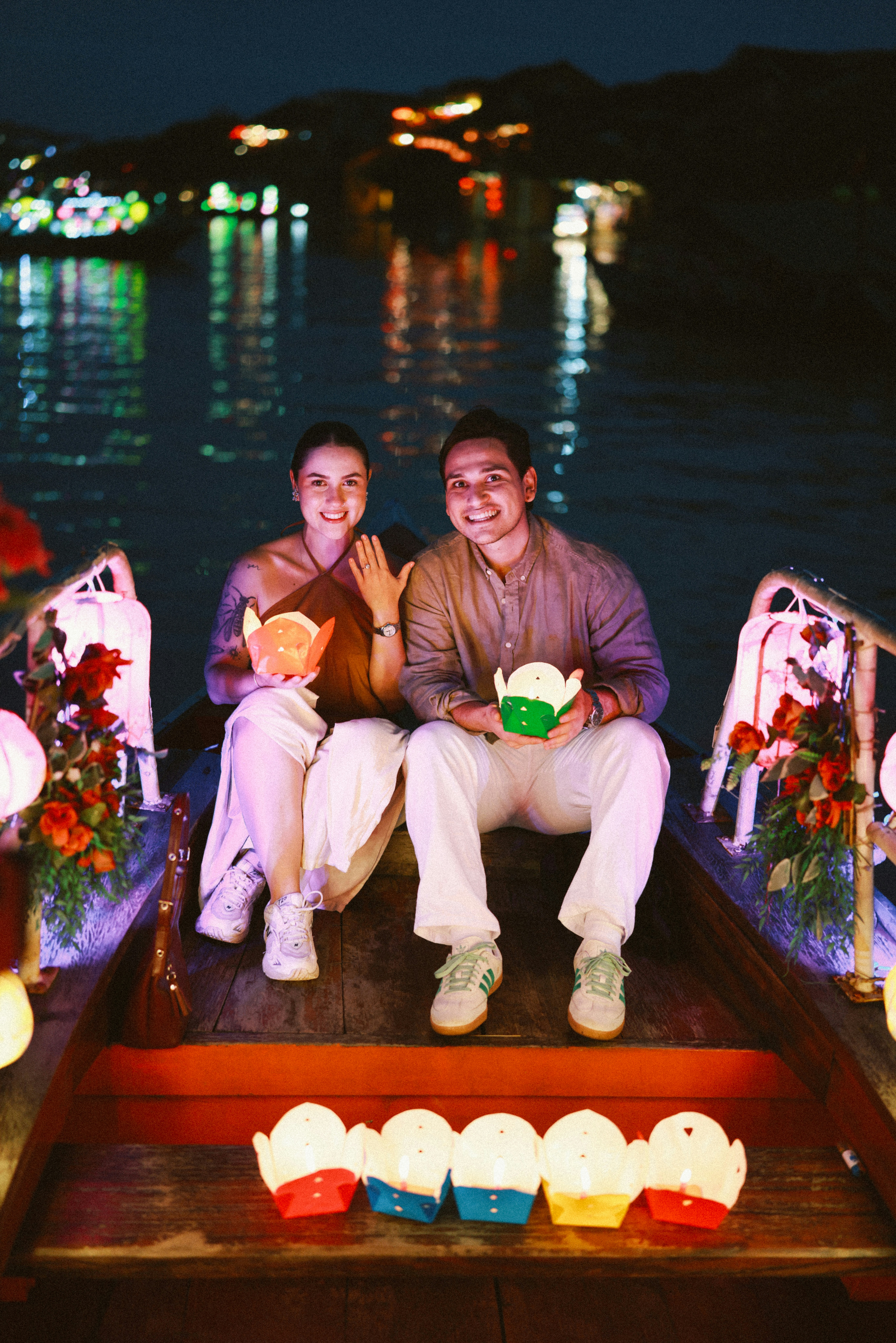 Lantern-lit Moment: A Nighttime Boat Ride with Two Smiles