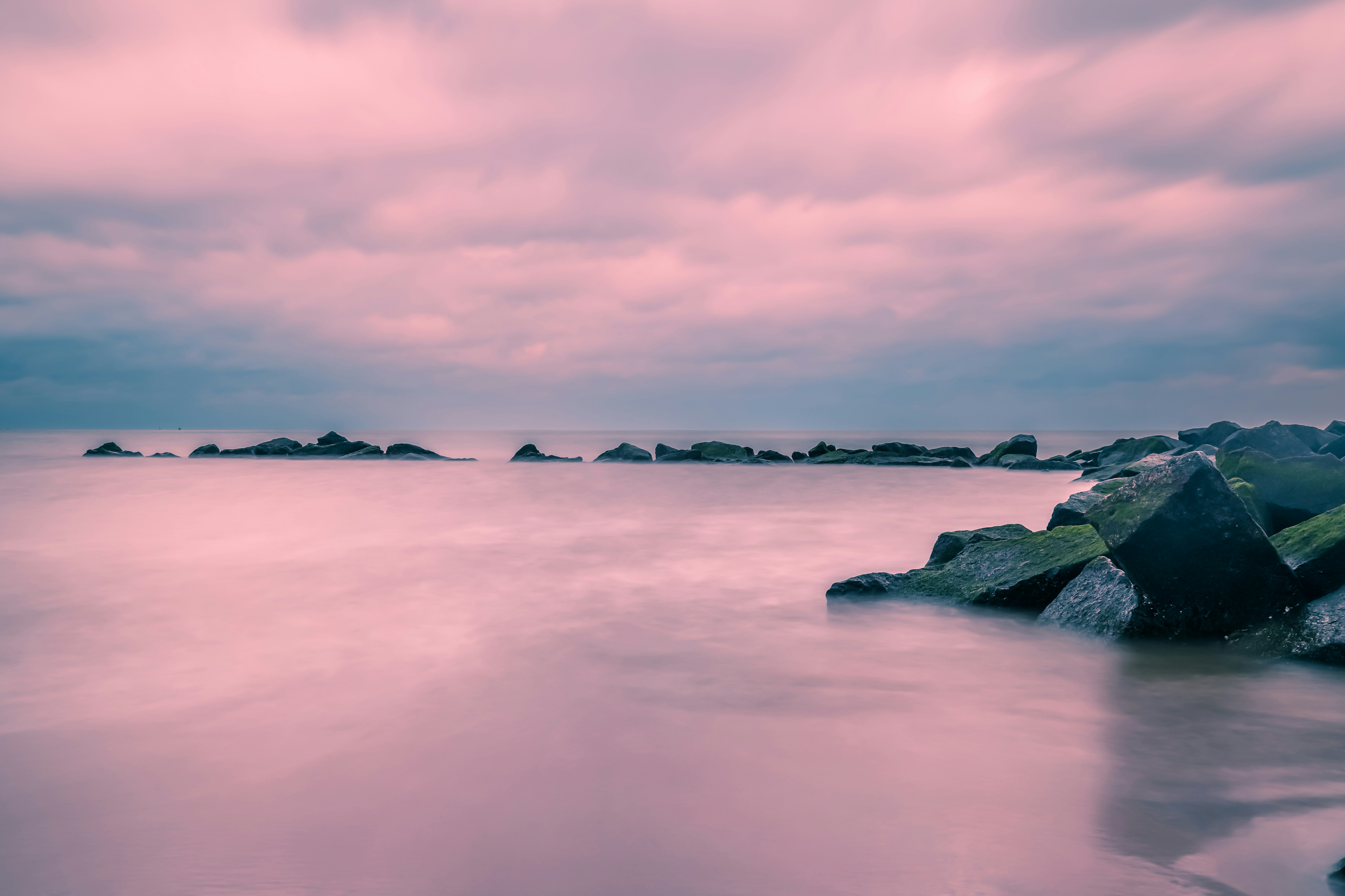 Rocks at Twilight: Pink Veil over a Quiet Sea