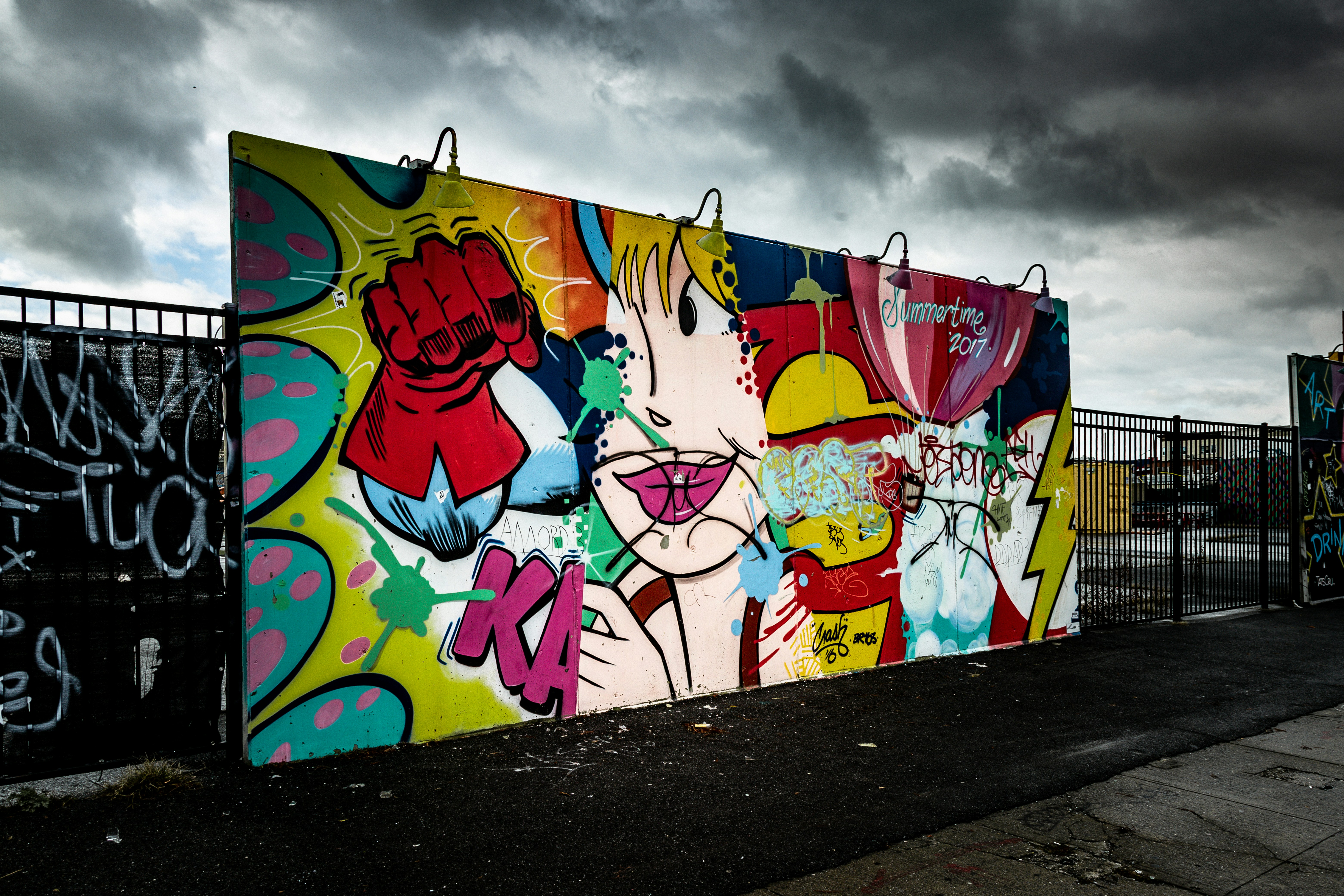 Colorful Guerrilla Canvas: A Riot of Pop Art on Urban Fence