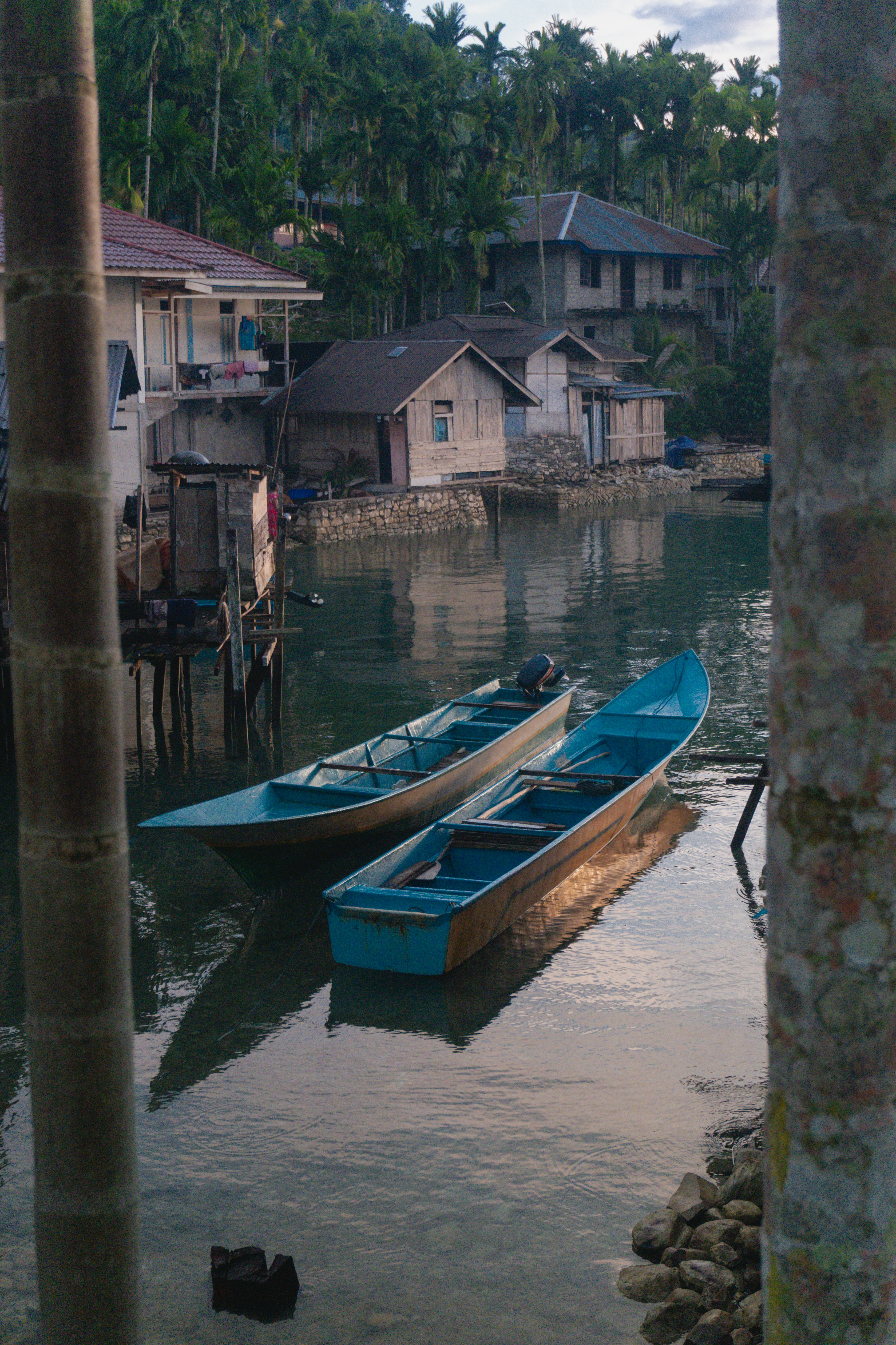 Boats and houses during sunrise at Werfra Village, Fakfak Regency, West Papua, Indonesia
