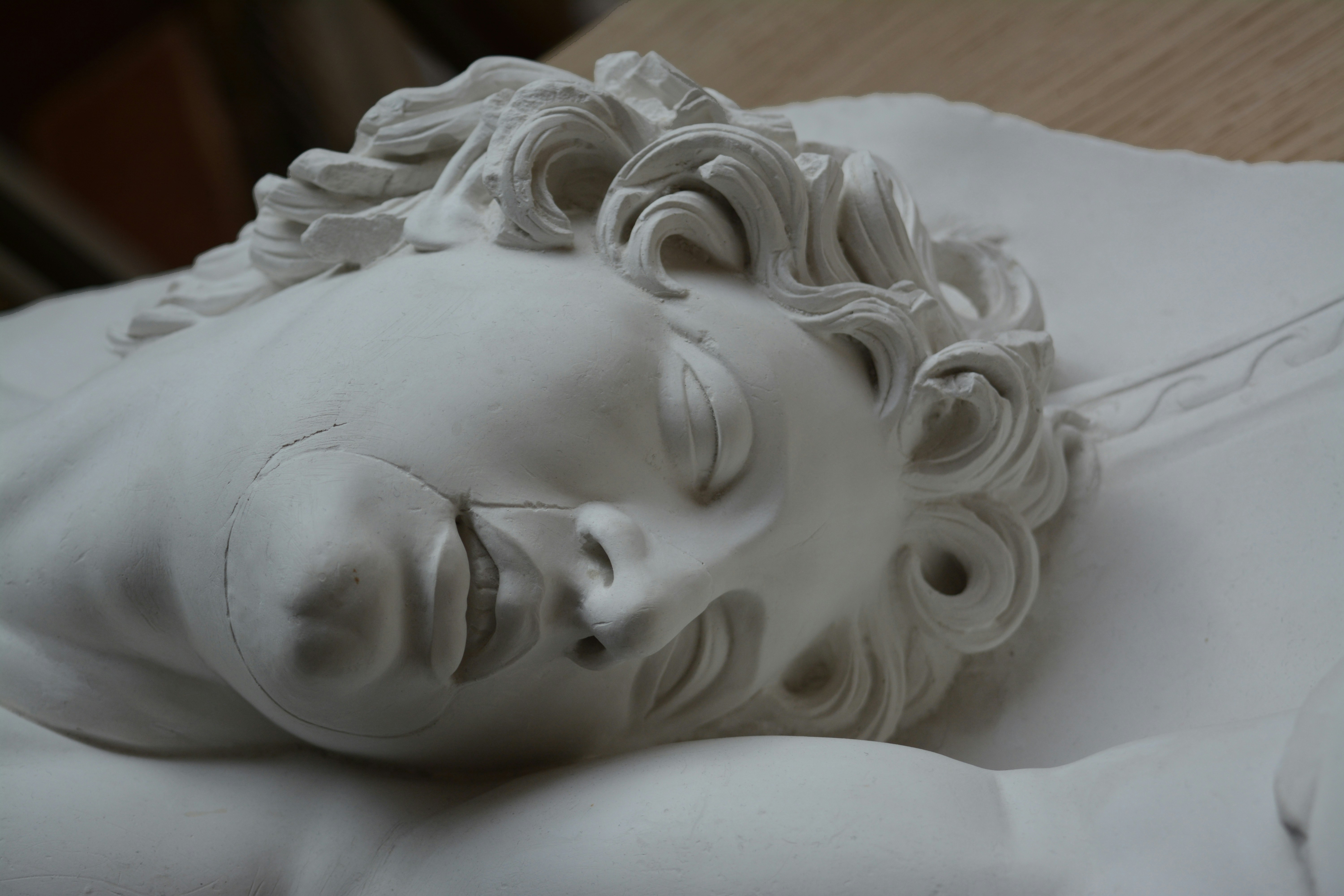 Whispers in Marble: a sleeping head carved in pale light