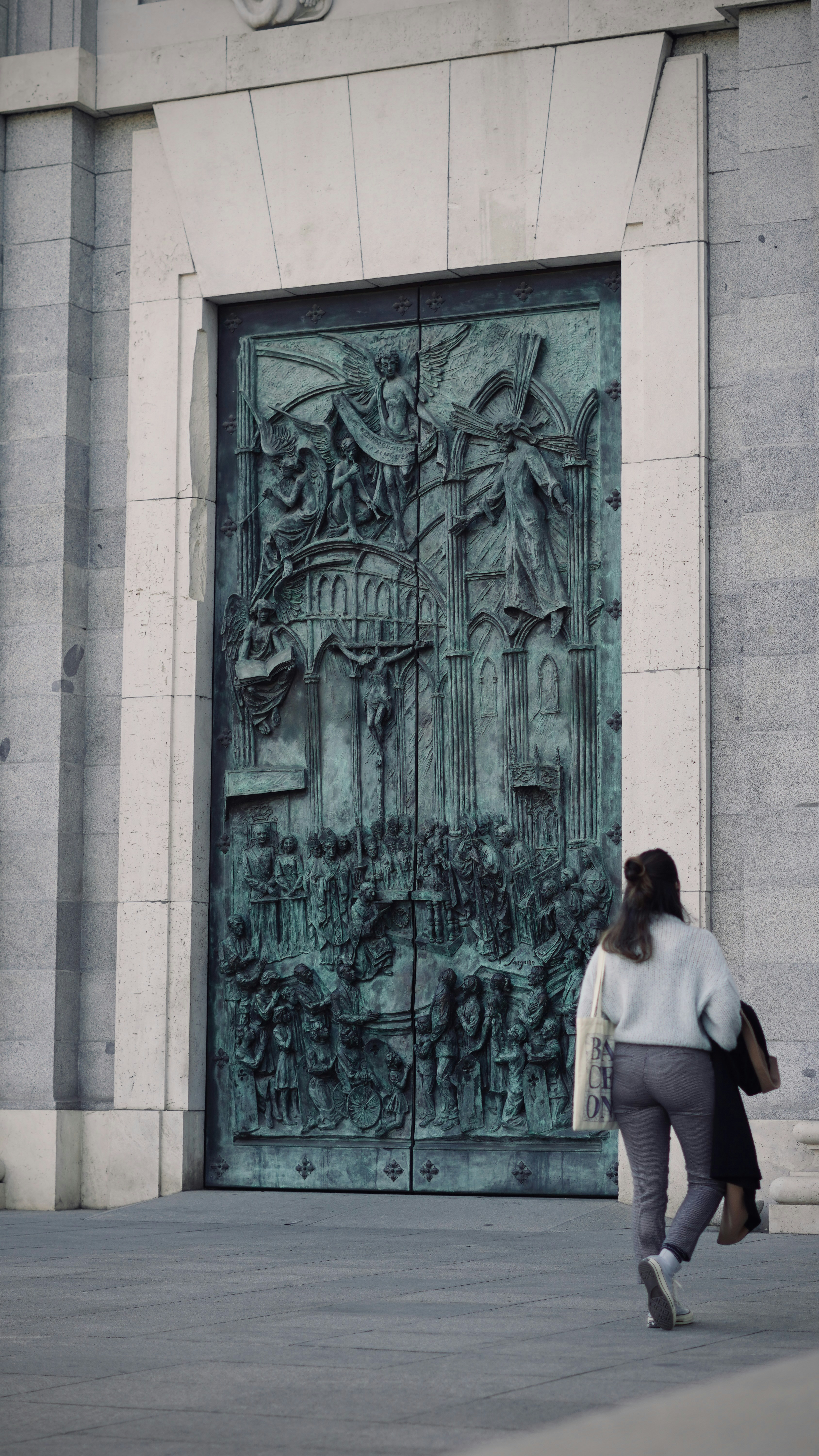 Approaching the Carved Threshold: A Pedestrian at the Monumental Bronze Door