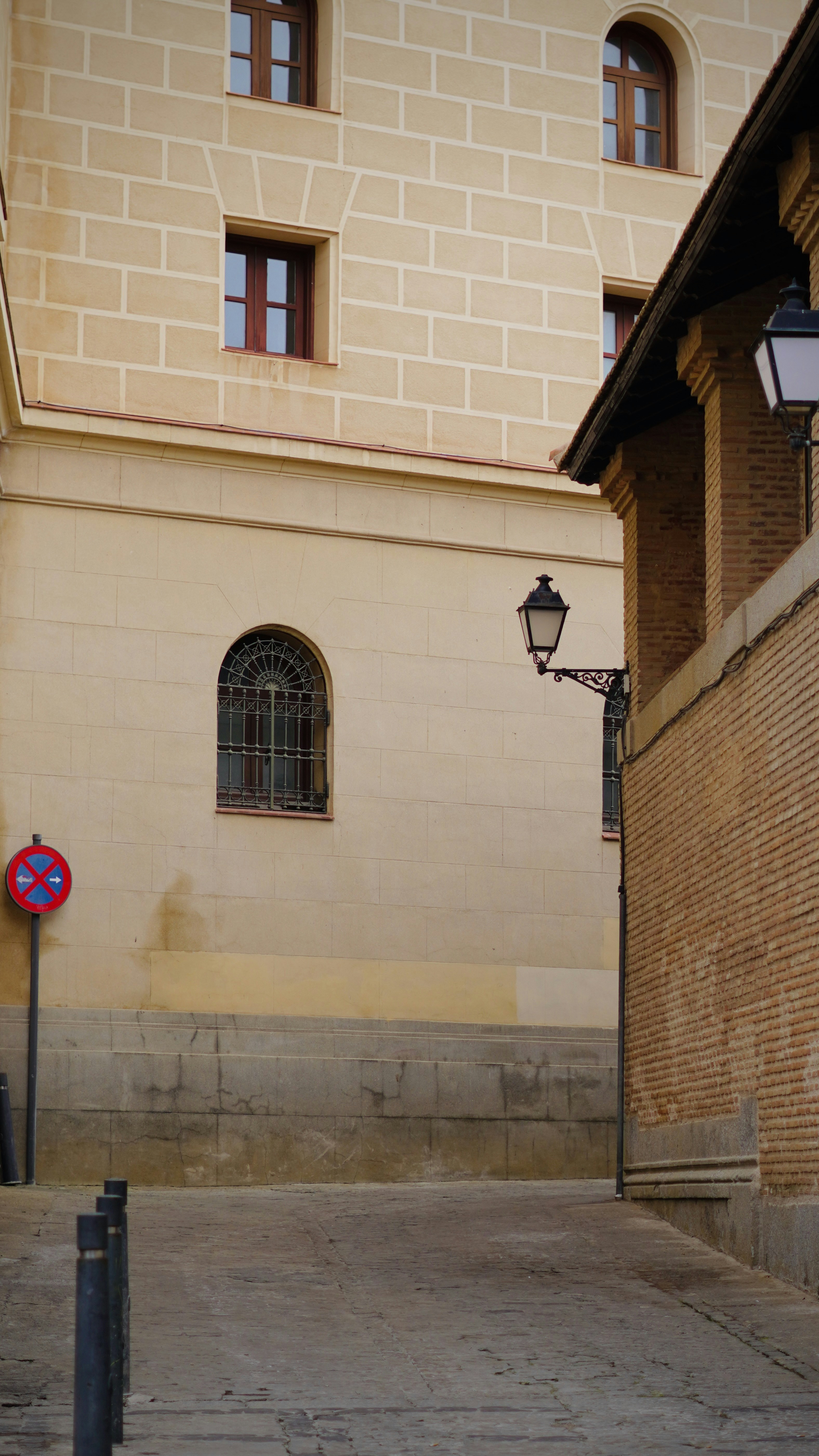 Arched Window and Street Lamp: Geometry in a Quiet European Alley