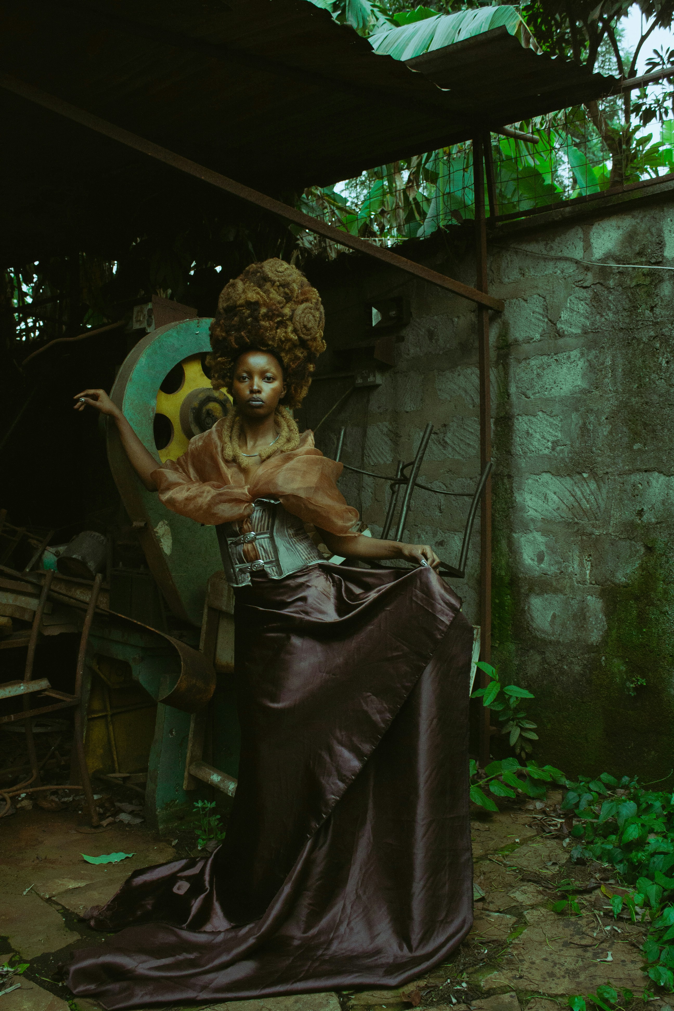 Portrait in a Garden Workshop: Regal Attire Against Machinery