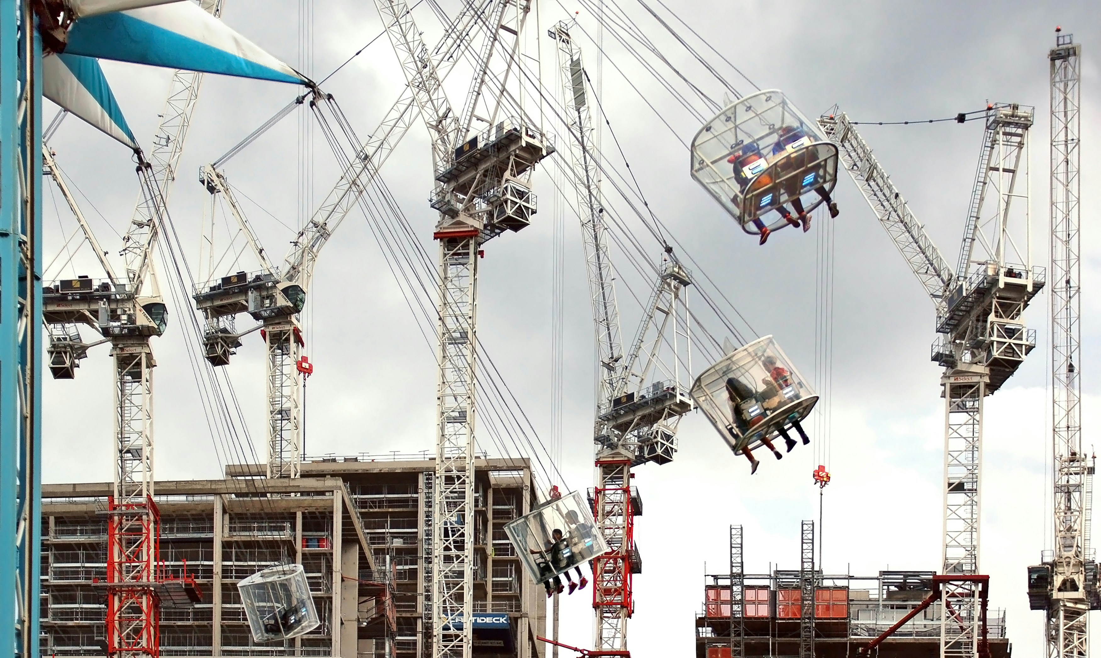 Gondolas Above the Grid: Cranes Hover Over a Bustling Construction Site