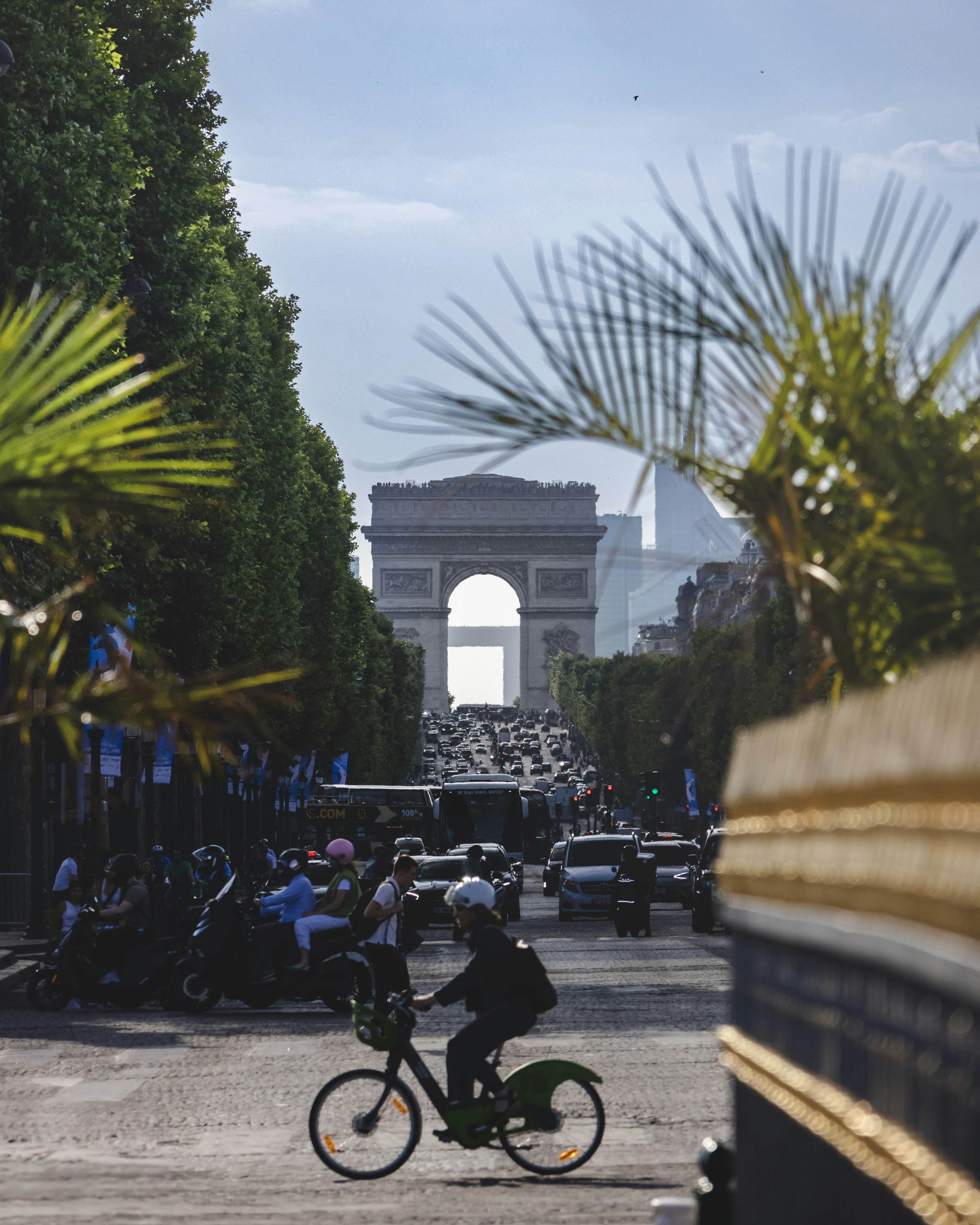 Arc de Triomphe Framed by a Palm-Tree Avenue on a Busy Paris Street