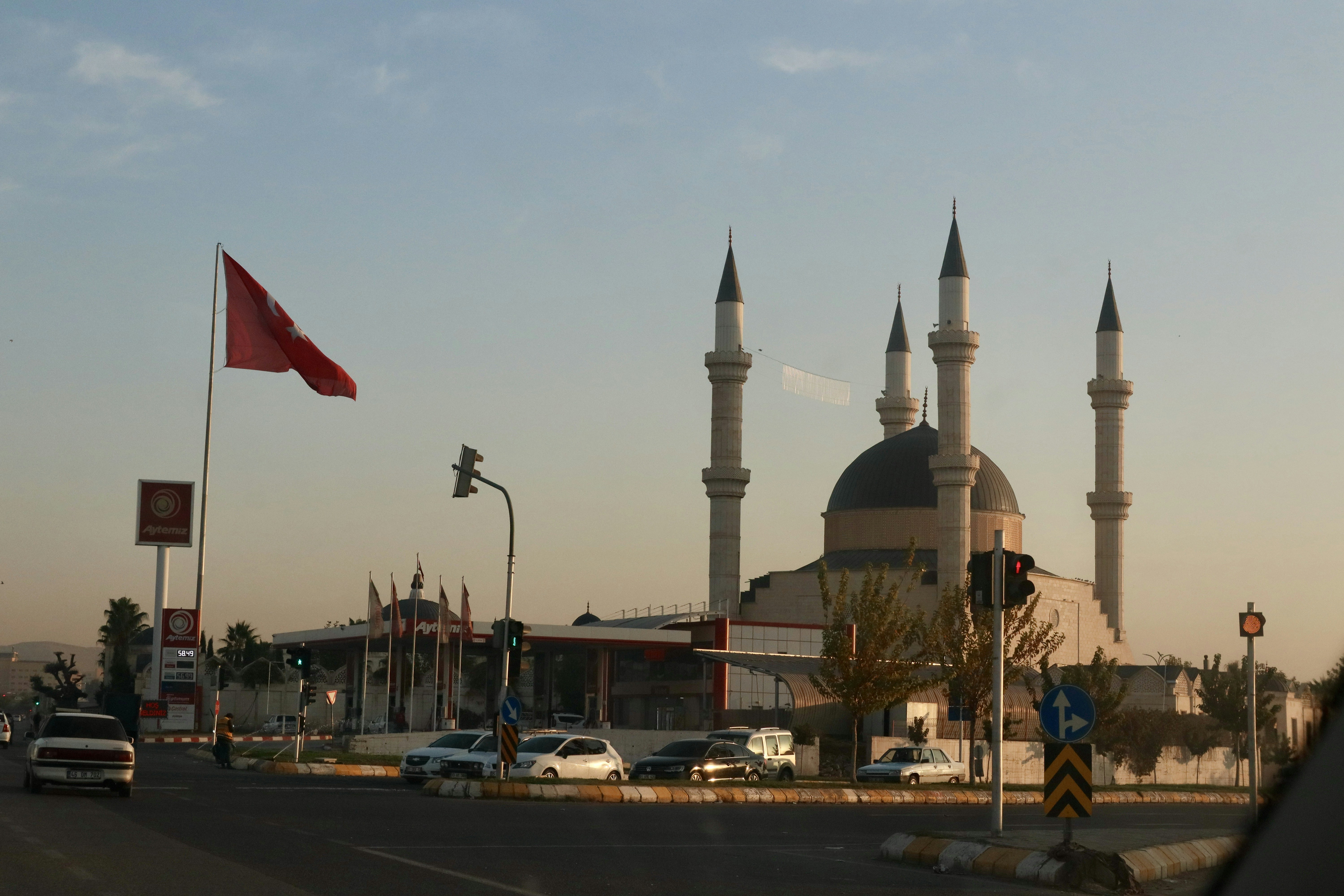 Golden Hour Minarets: Street, Car Lights, and a Mosque