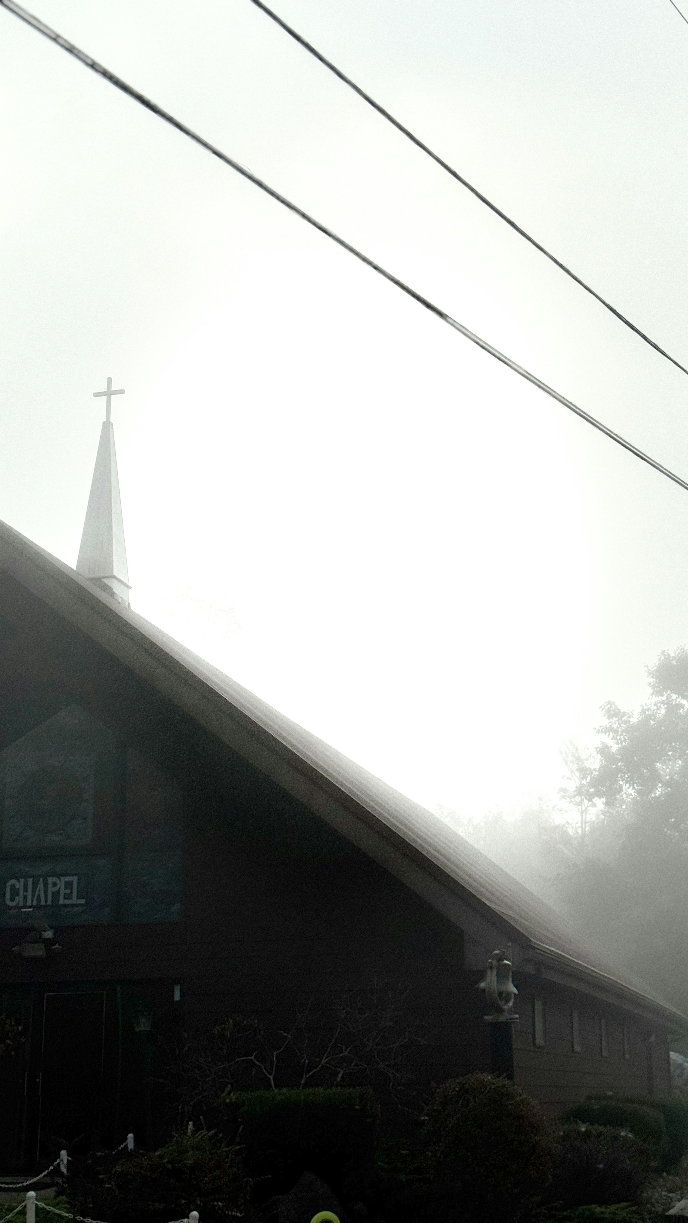 Dawn's Cross Over a Misty Chapel