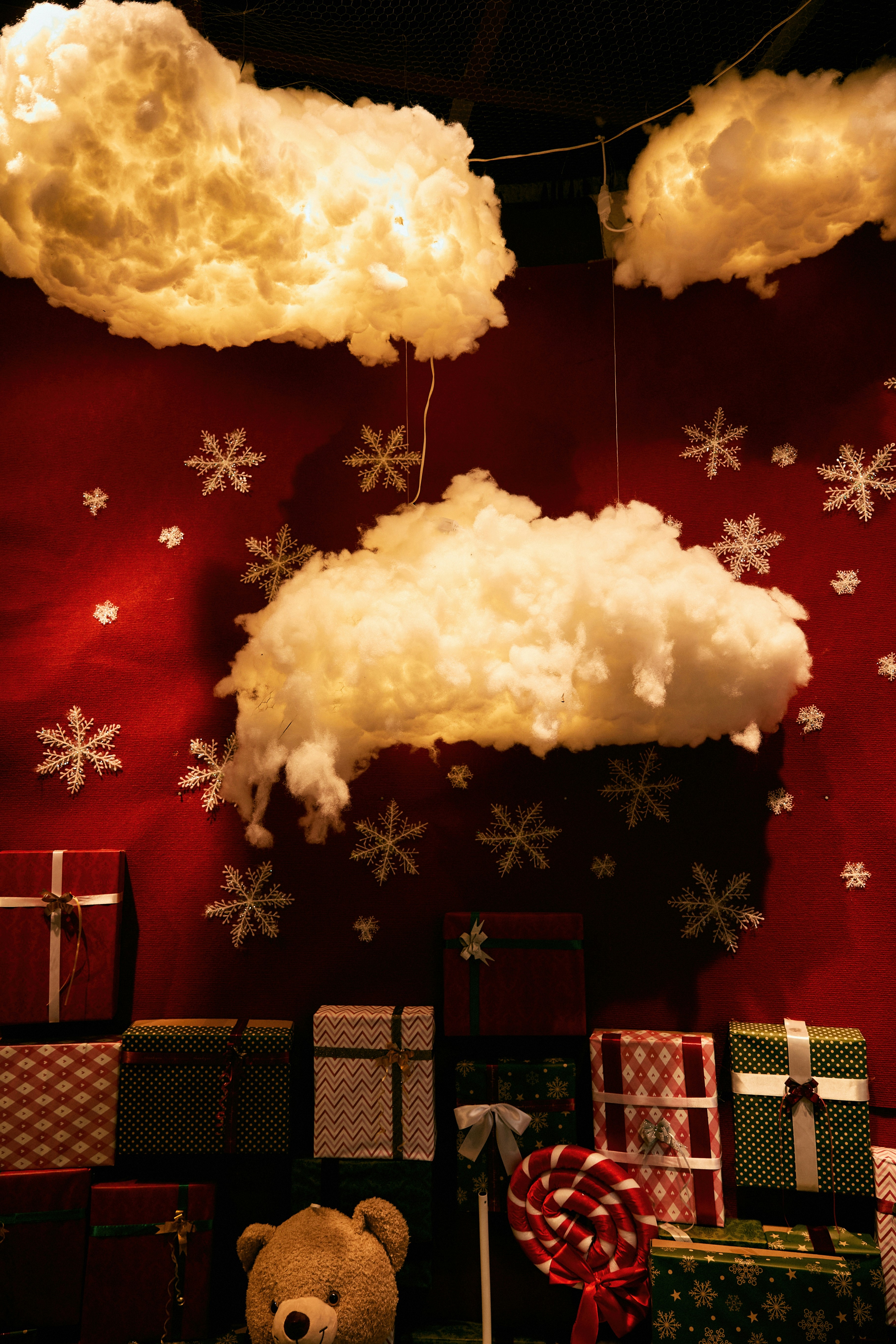 Floating Cloud Ornaments Above a Cozy Holiday Gift Display