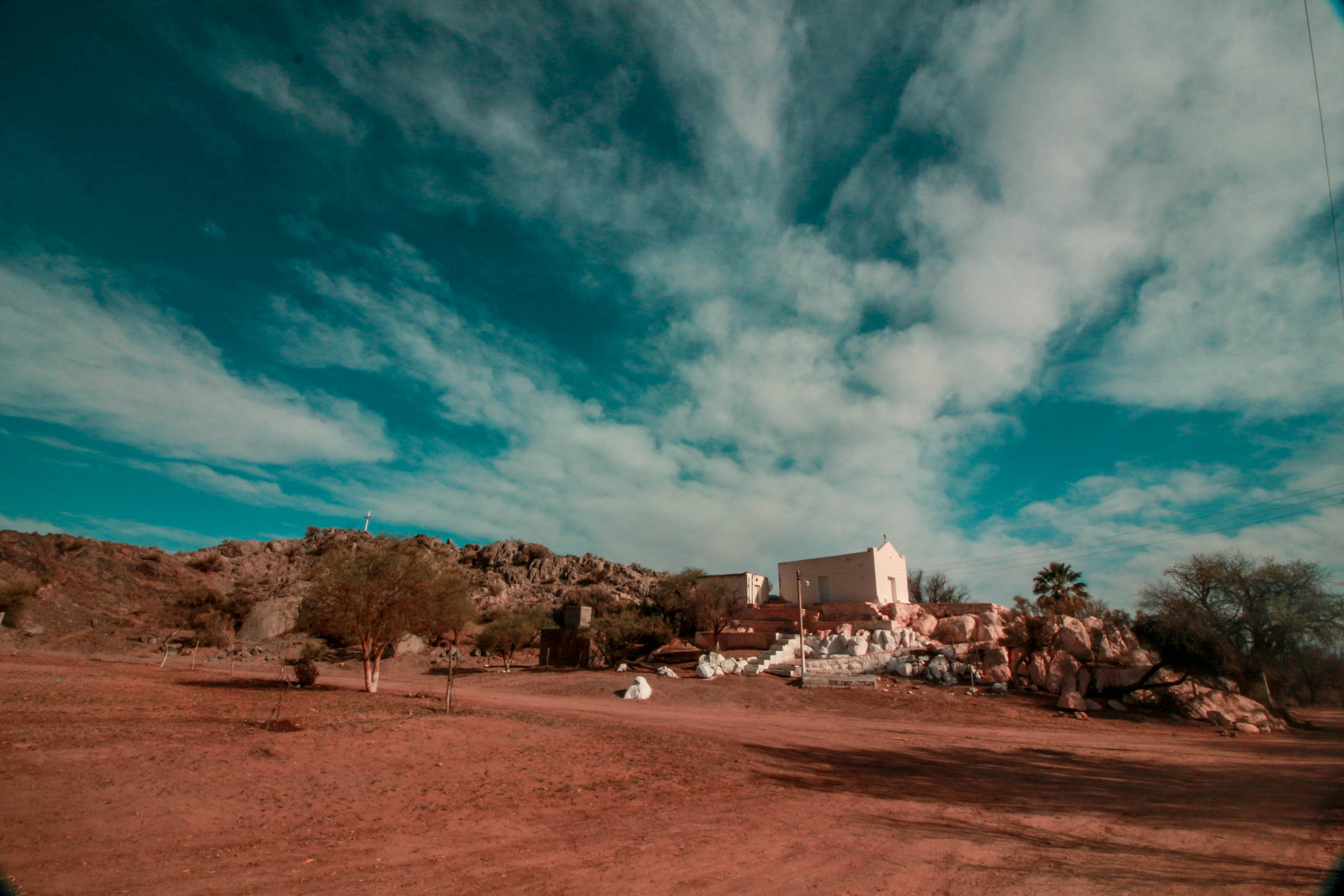 Desert Hilltop Lodge under a Vast Cloudscape