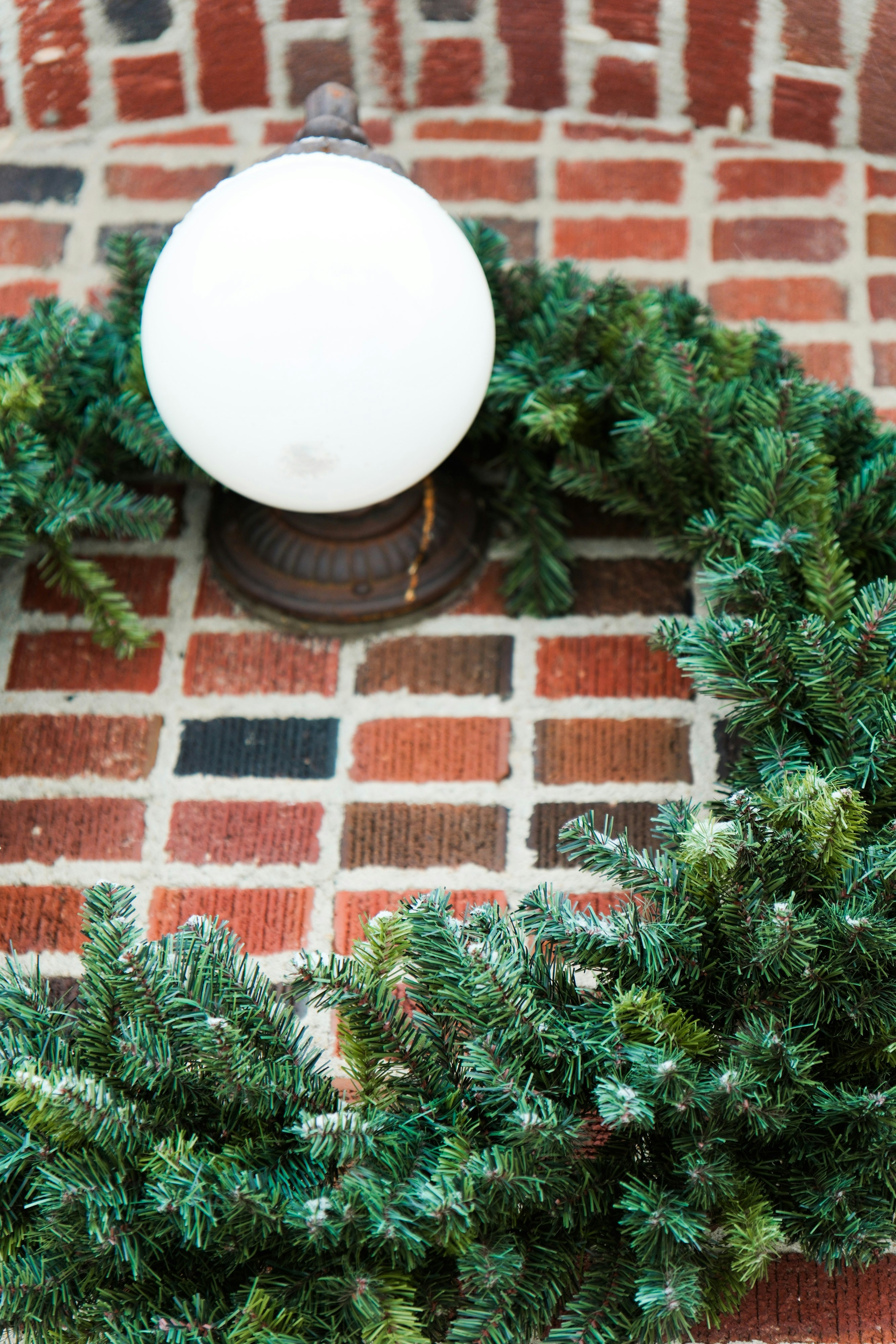Lantern in the Wreath: a brick courtyard vignette