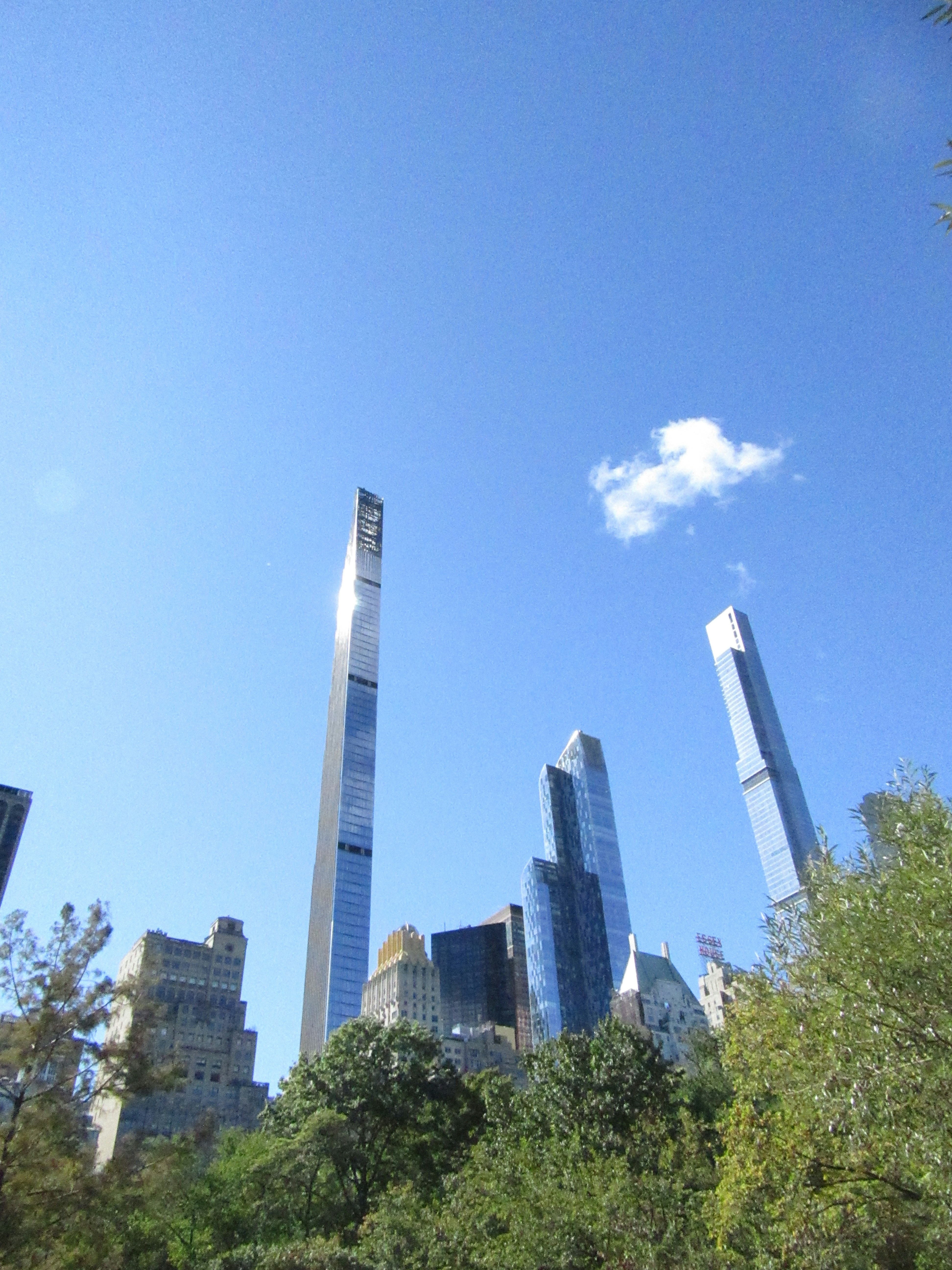 Tall skyscrapers in New York City, as seen from the midst of Central Park