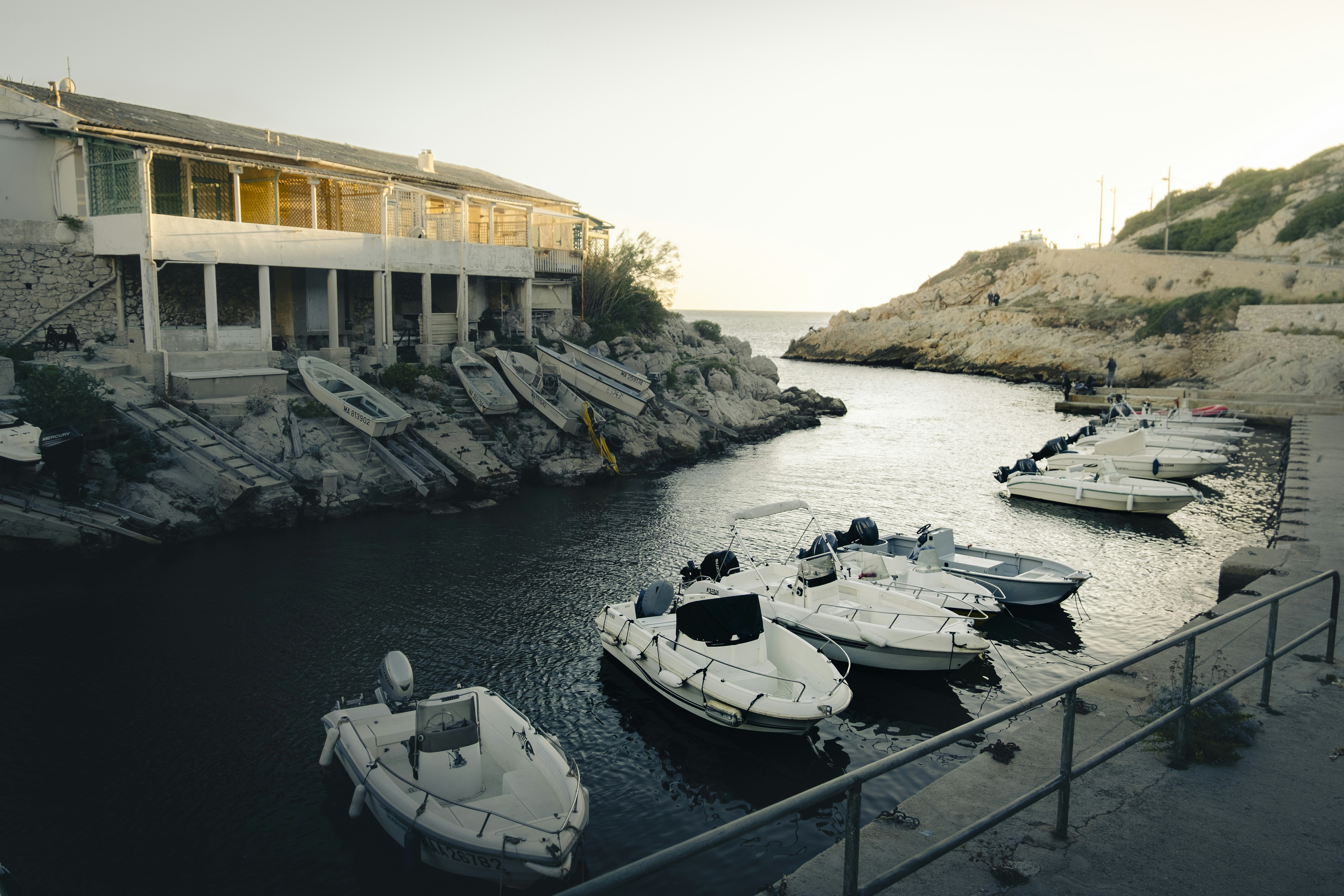 Harbor Mosaic: Boats Quietly Framed by Stone and Sea