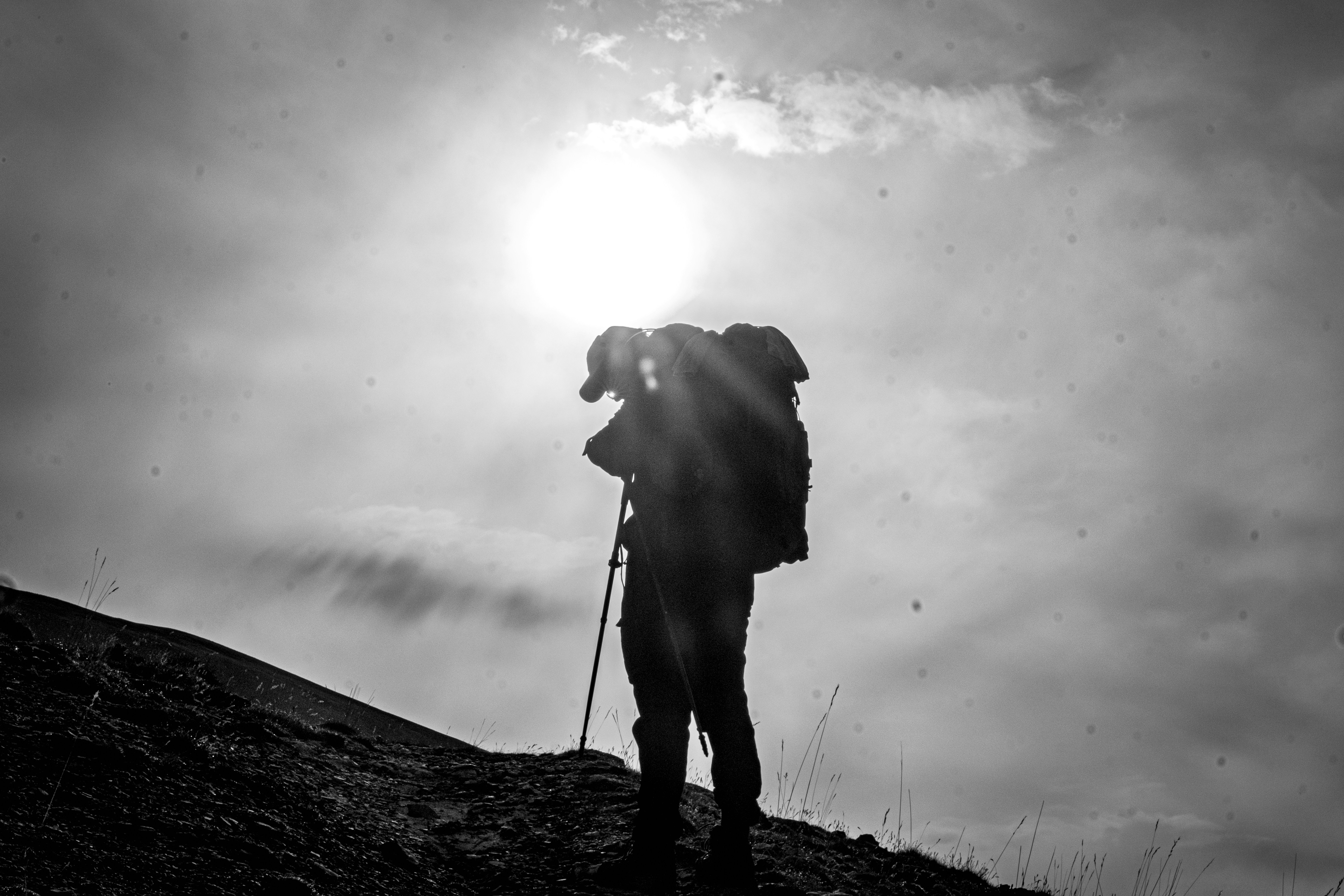 Silhouette Summit: A Lone Hiker Beyond the Horizon