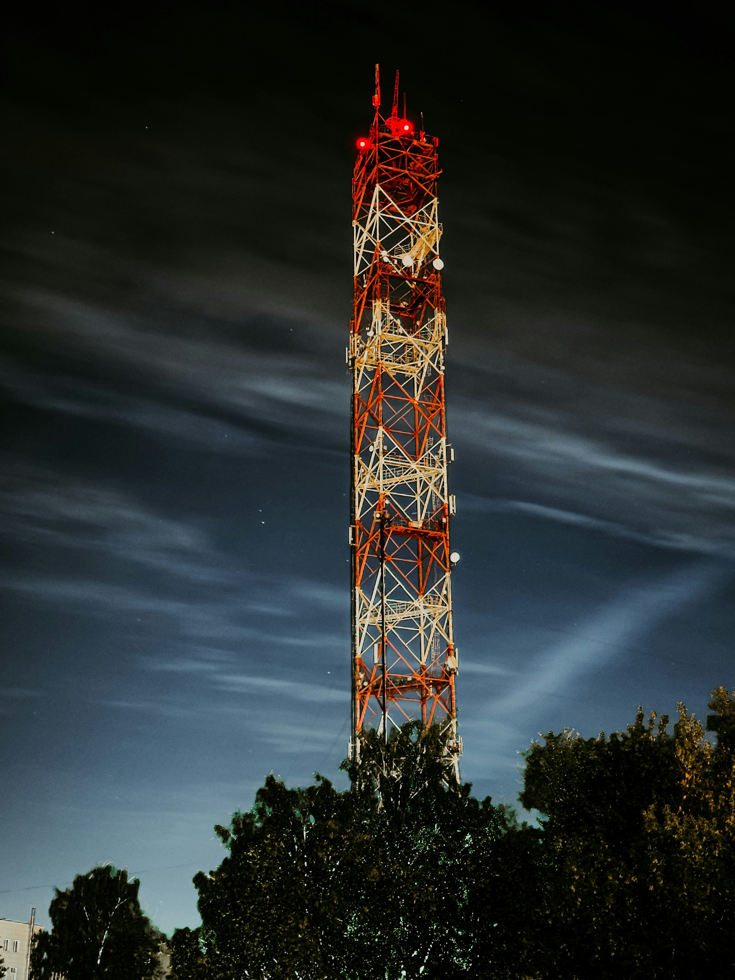 Night Broadcast Tower Rising Above Quiet Trees