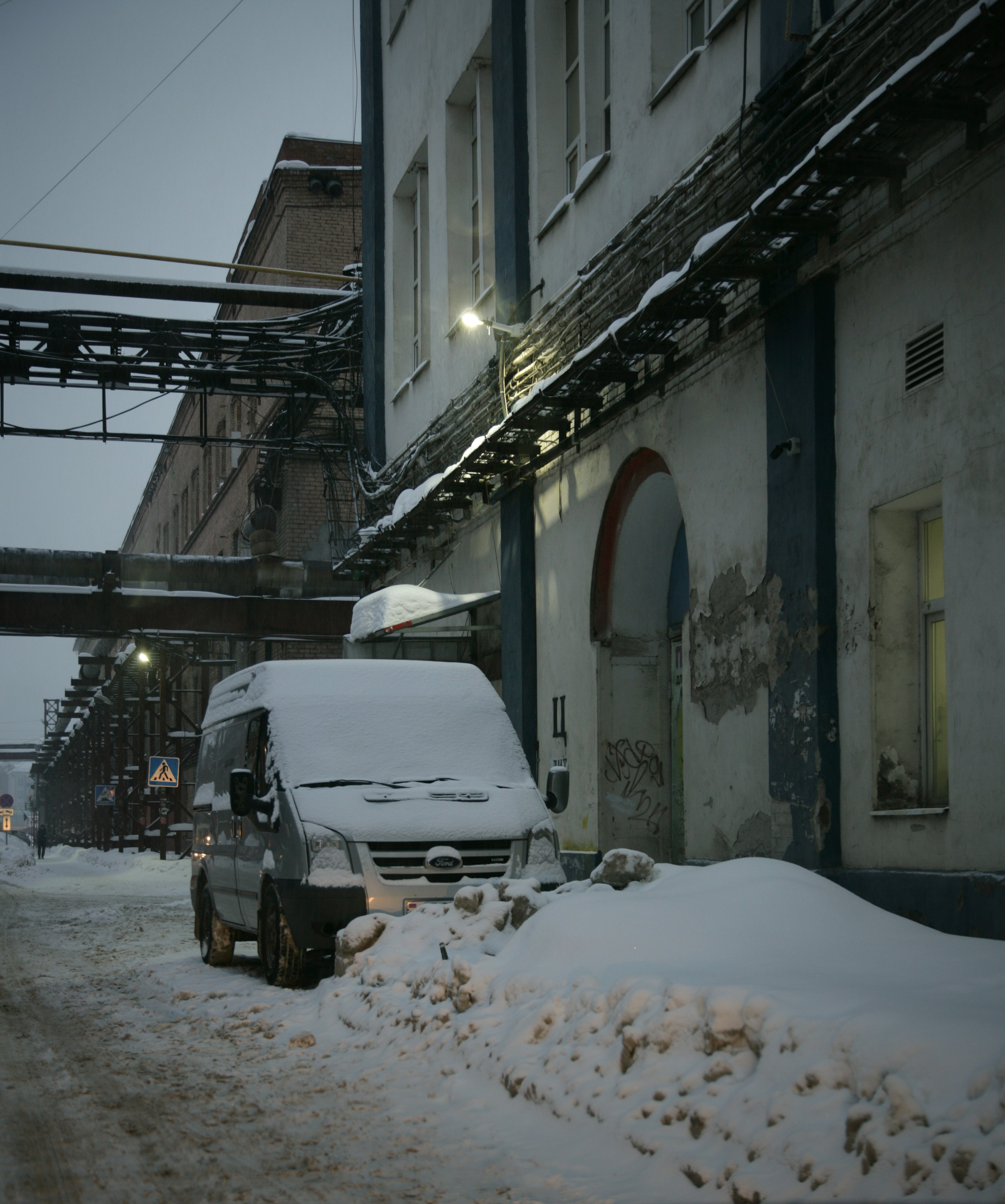 Snowbound Van under a Weathered Canopy