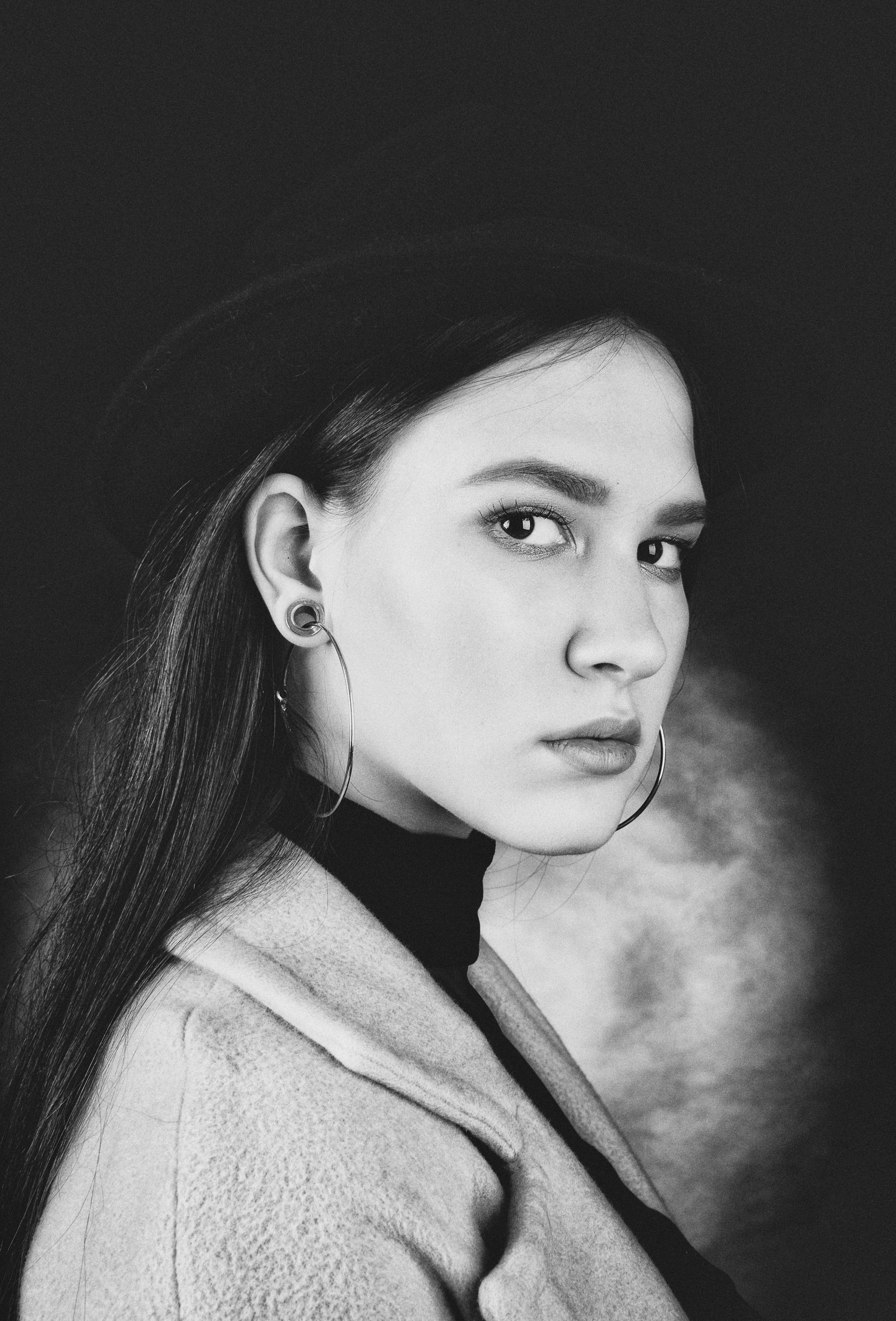 Monochrome Gaze: A poised portrait under a shadowed hat