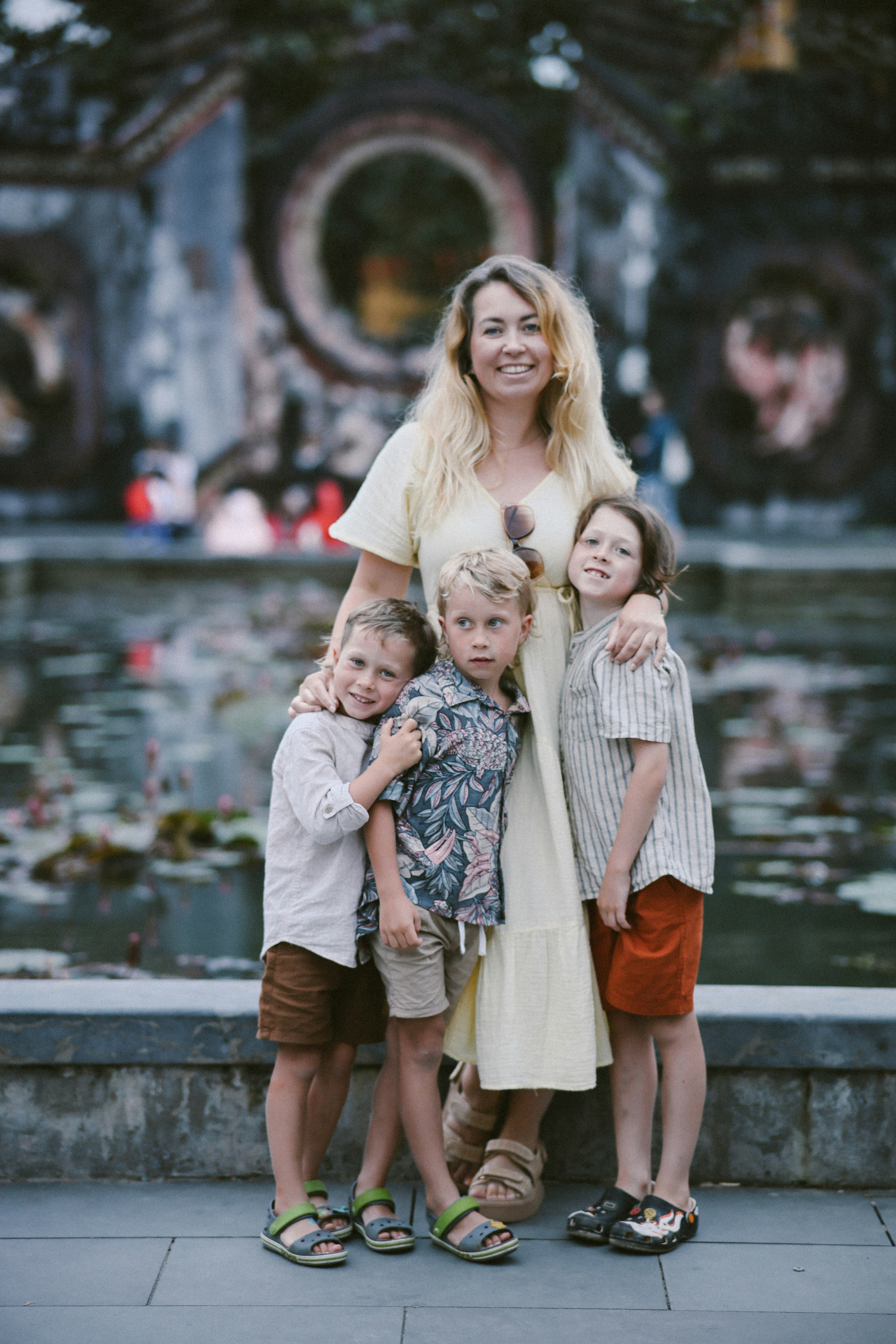 Circle of Joy at the Fountain: A Mother's Embrace with Four Children