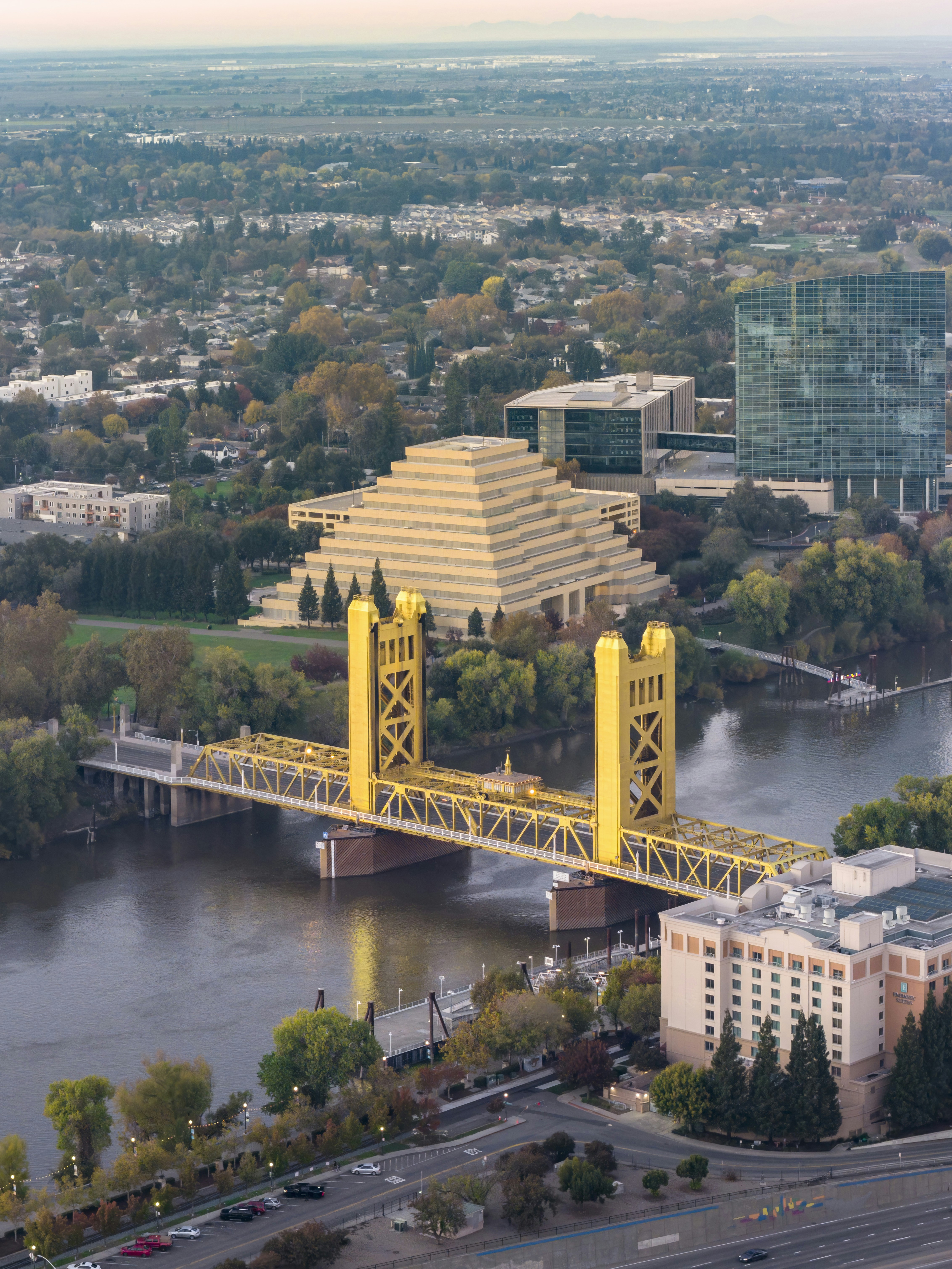 Golden Bridge Towers Framing a Riverside Cityscape