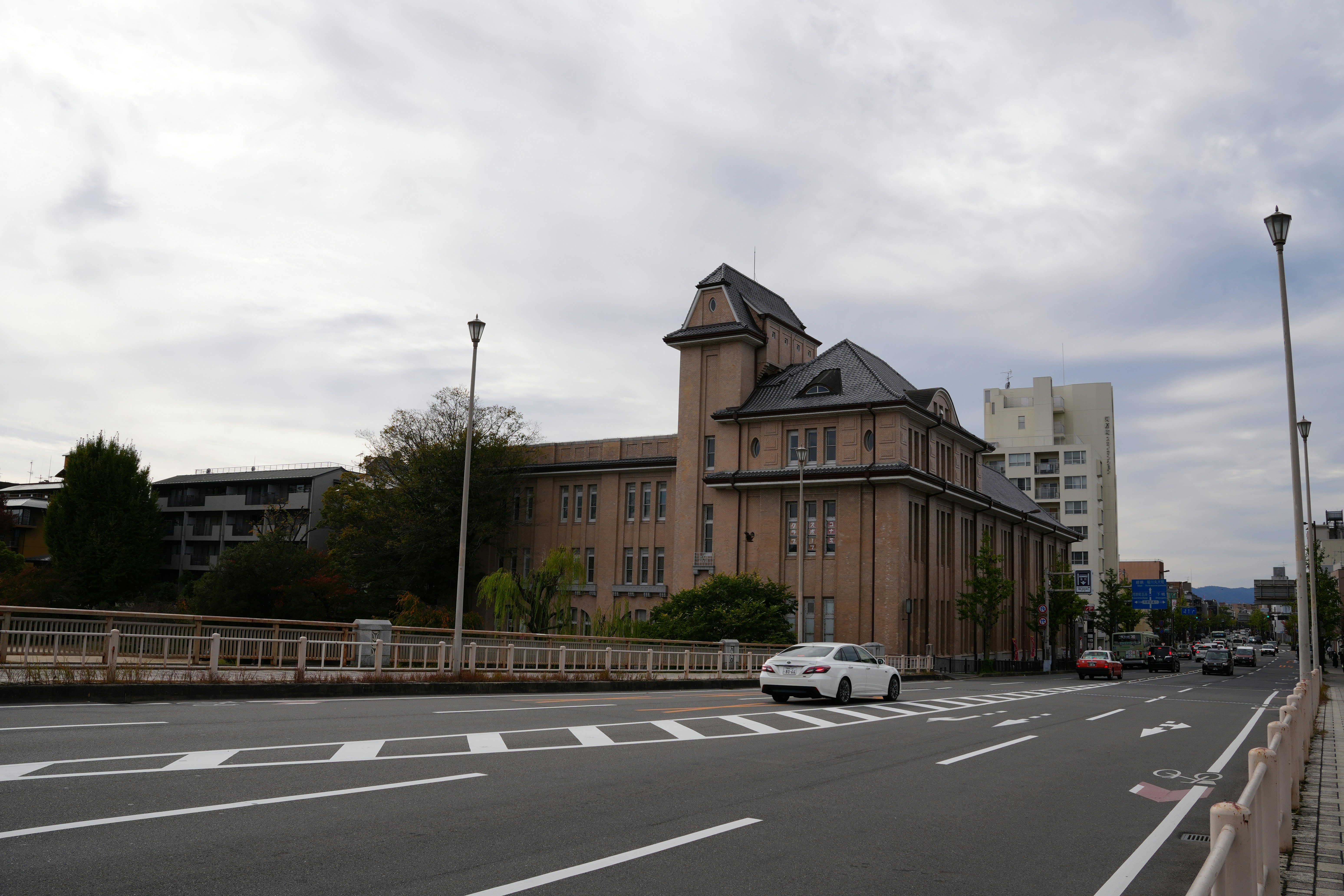 Brick Tower at the Corner: A Quiet Street Under Overcast Skies