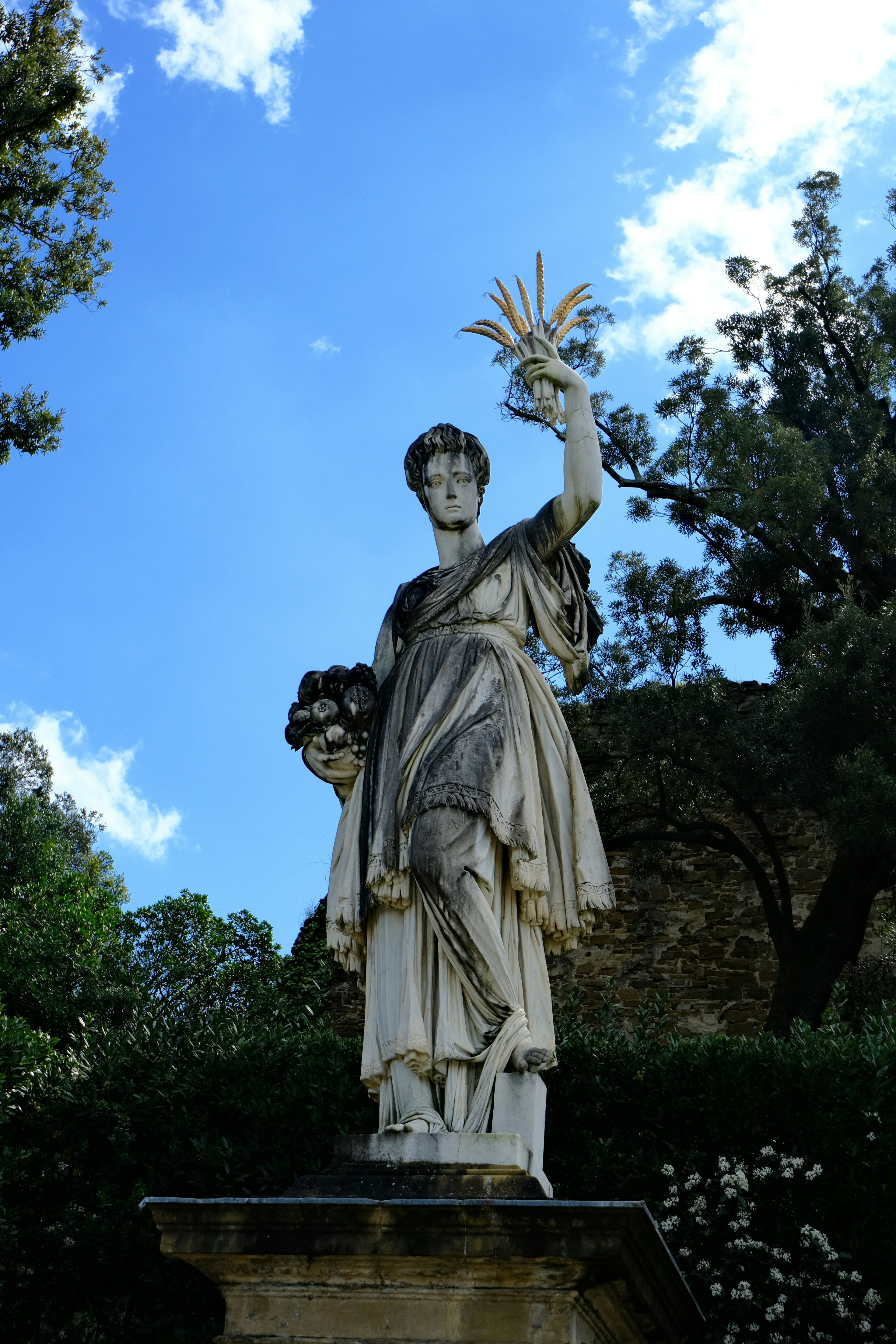 Herald of the Garden: Classical Statue Reaching Toward the Sky