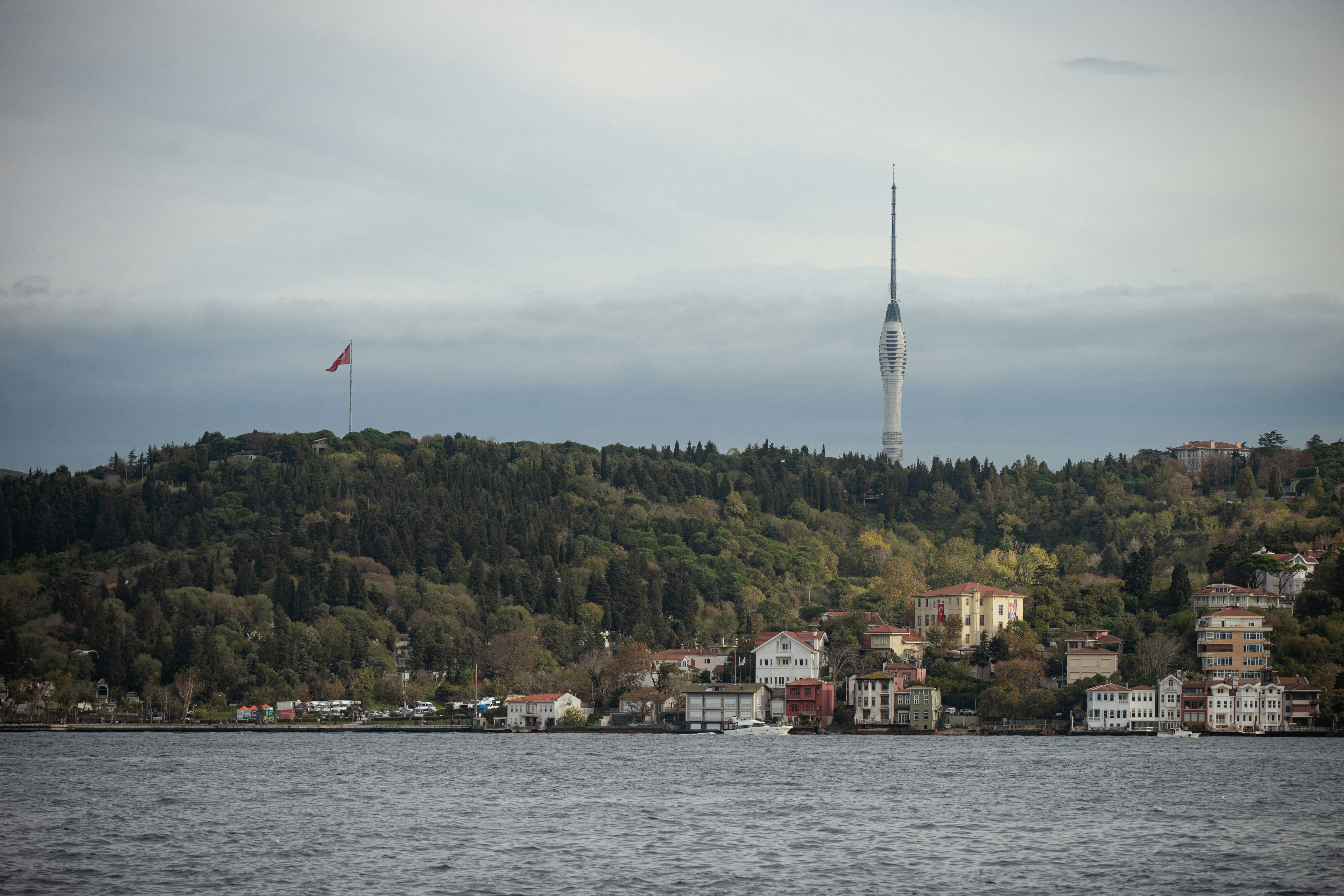 Coastal Town Silhouette under a Distant Tower