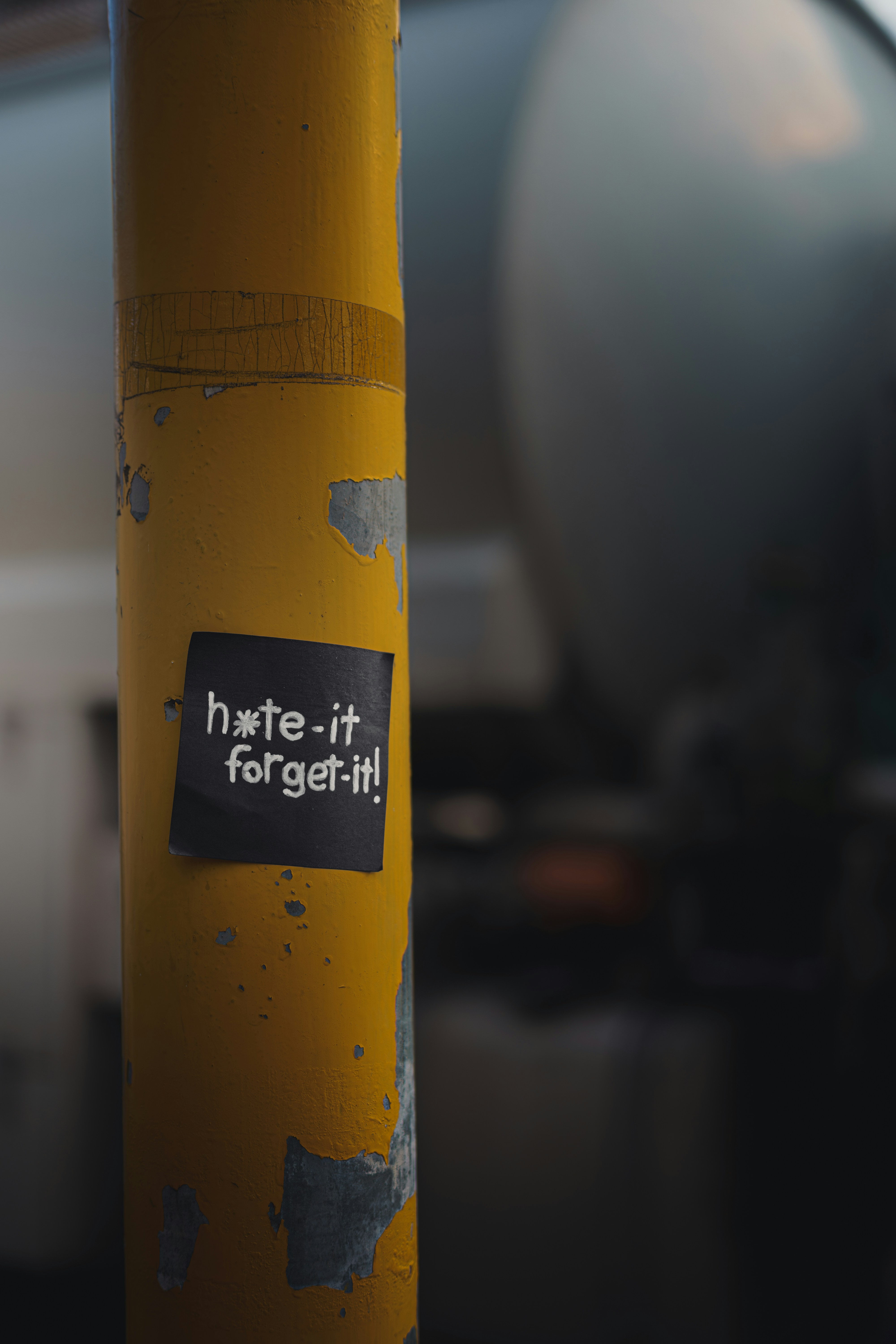 Sticky Note of Memory on a Weathered Pole