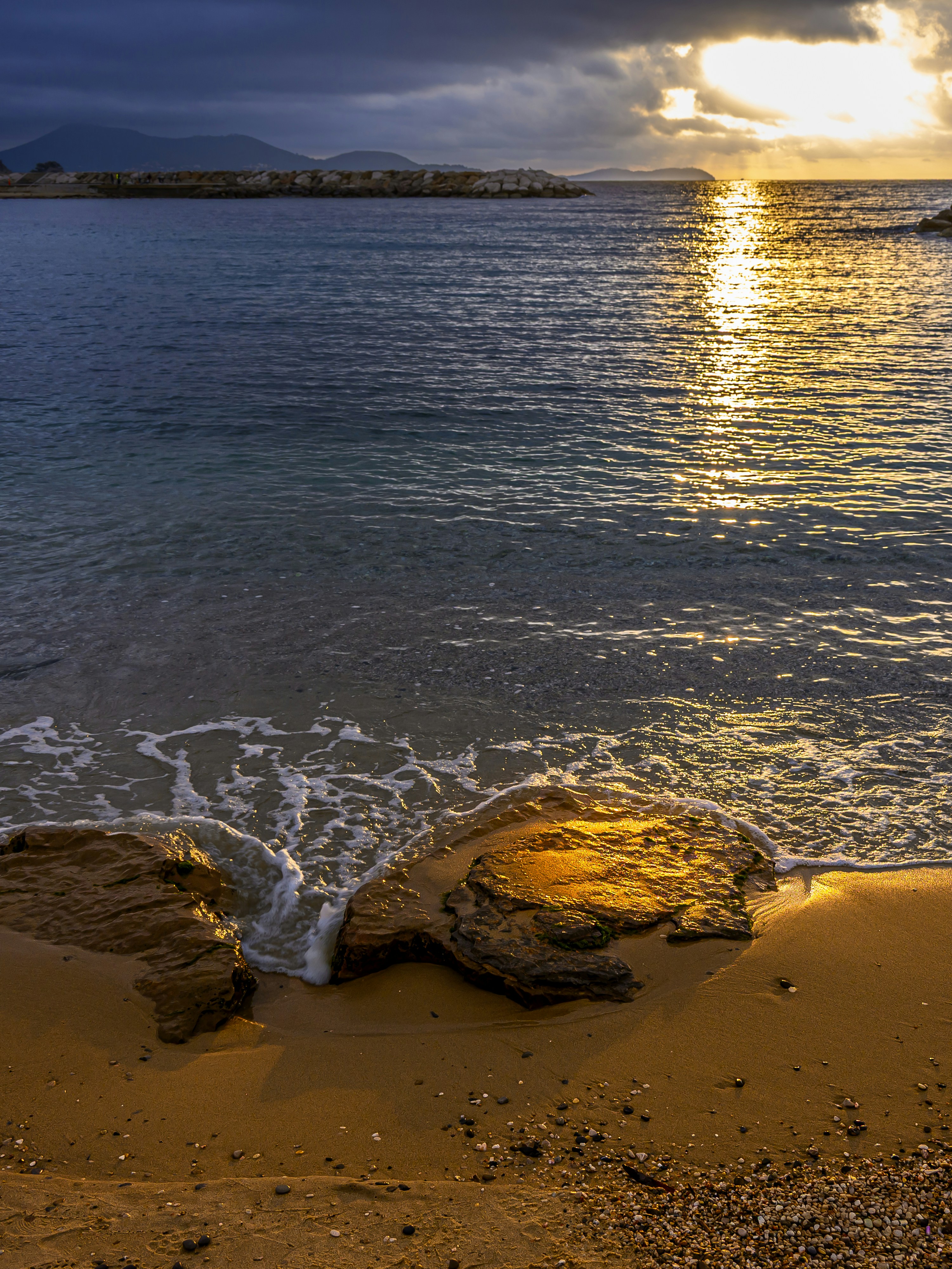 Golden Foothill: Sunlit Rocks Meet Tidal Light at Dusk