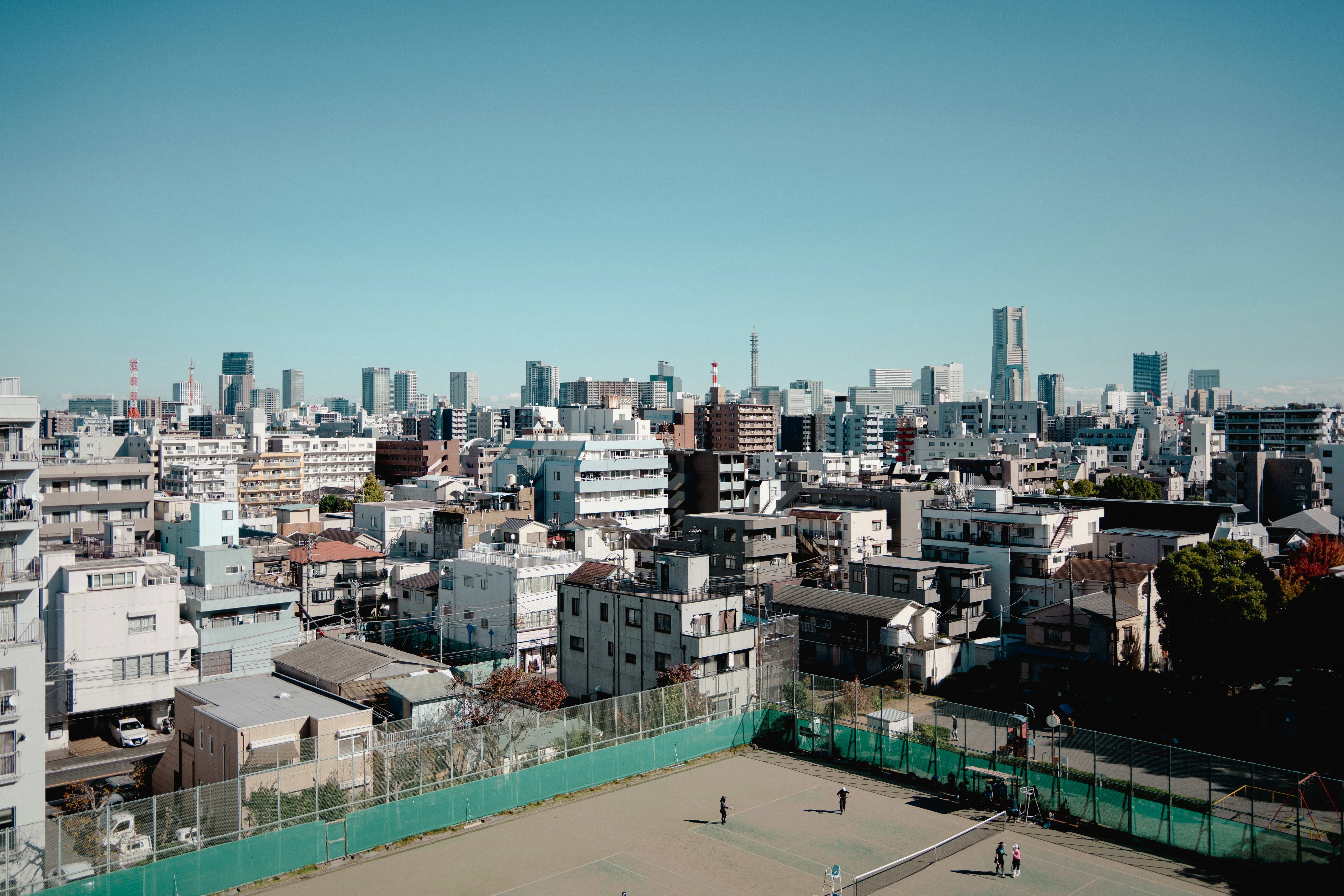 Urban Mosaic: A Quiet Playground Beneath a Clear City Sky