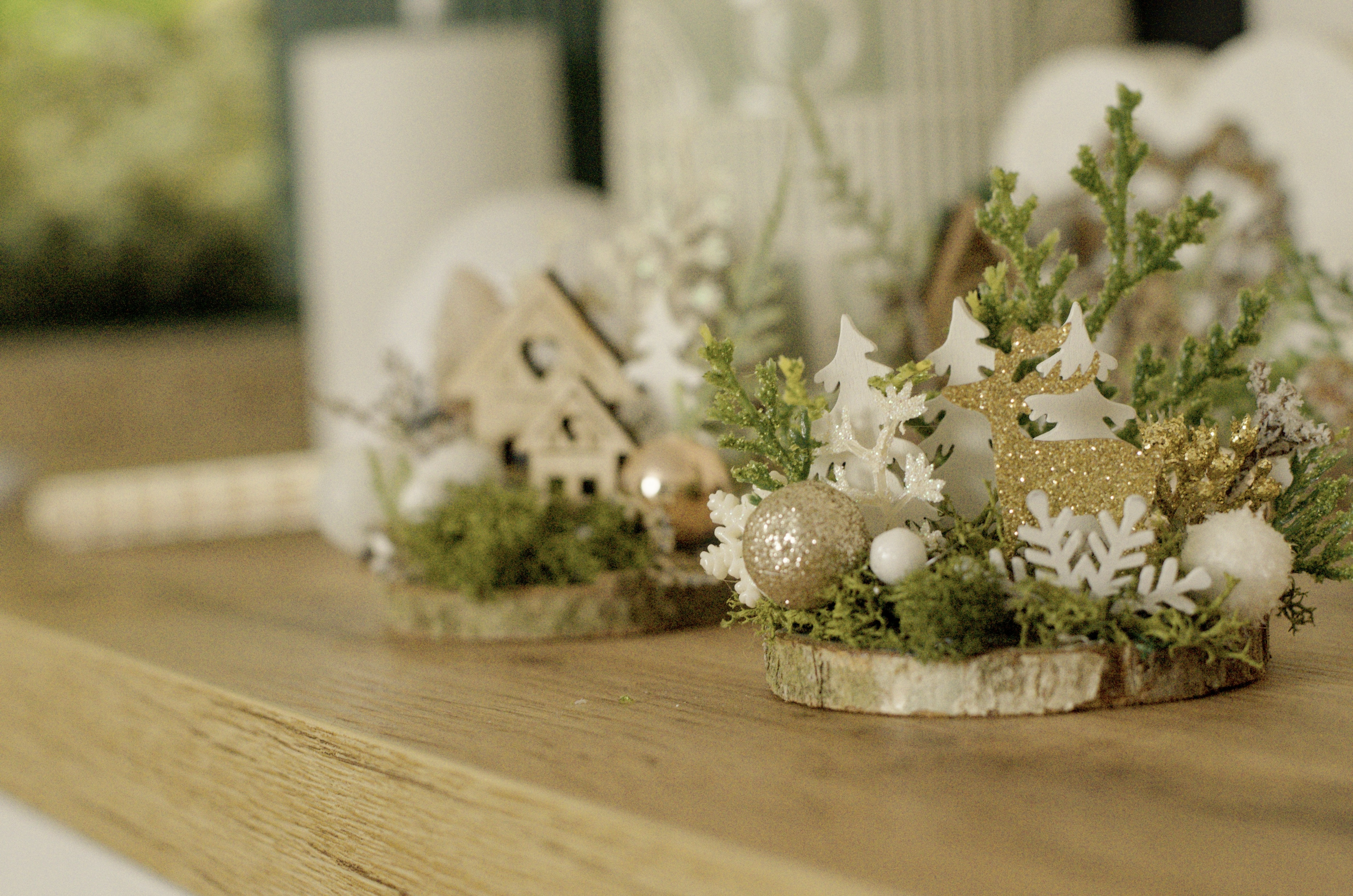 Miniature winter village centerpiece on a wooden surface