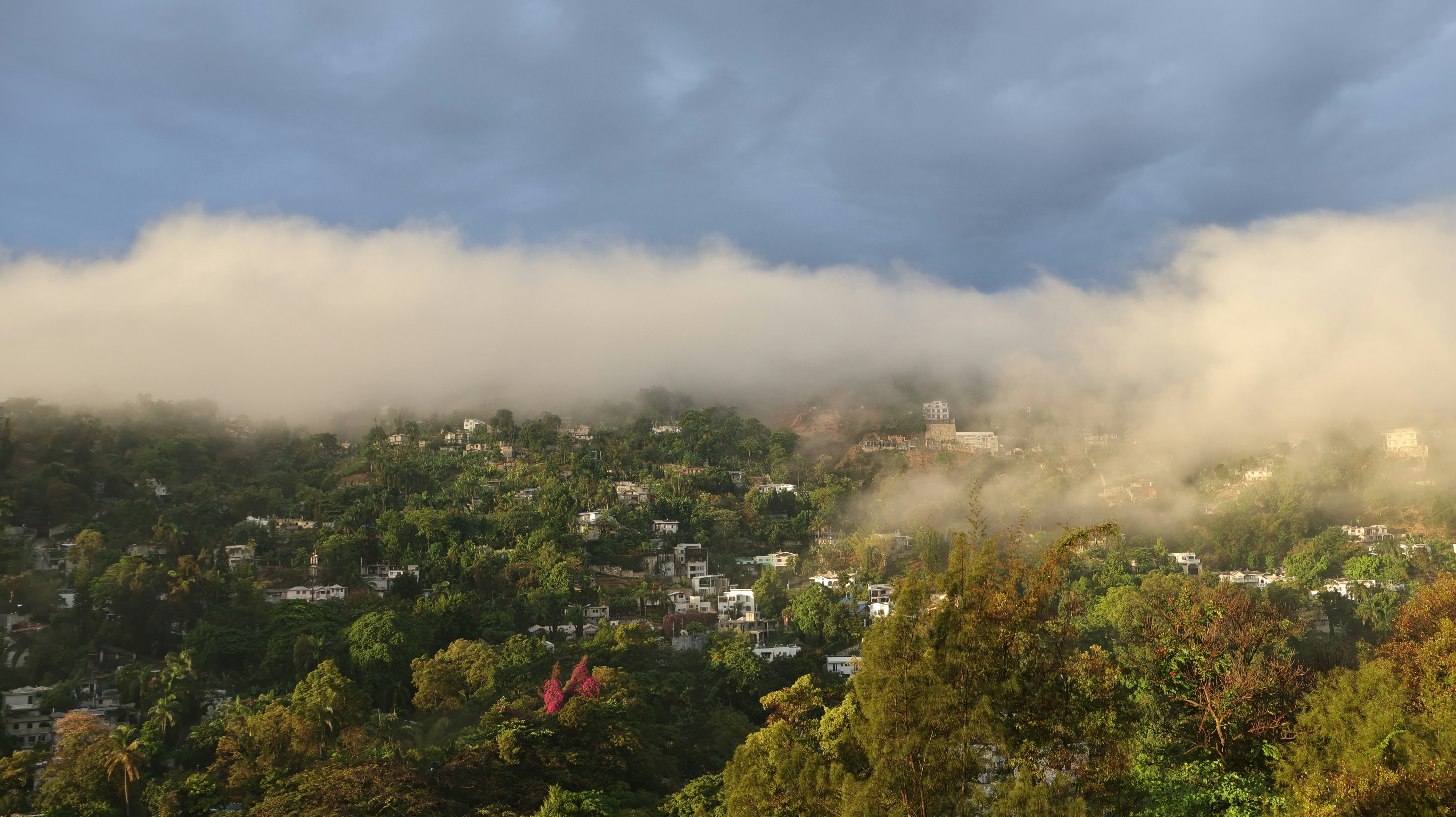 Misty Ridge: Village Fringes under Low-Cloud Loom